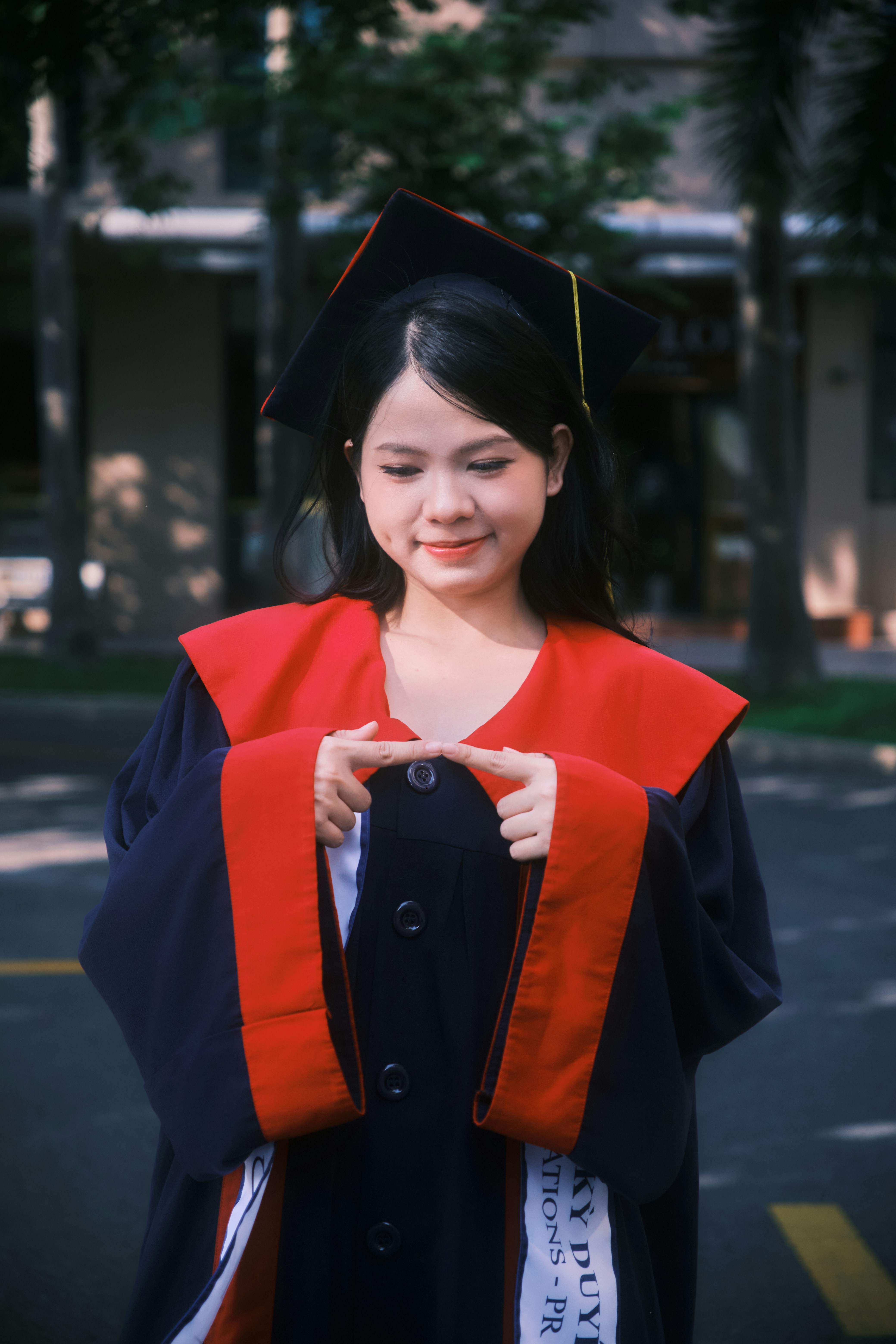 Graduate in Focus: A Confident Moment in Red and Navy