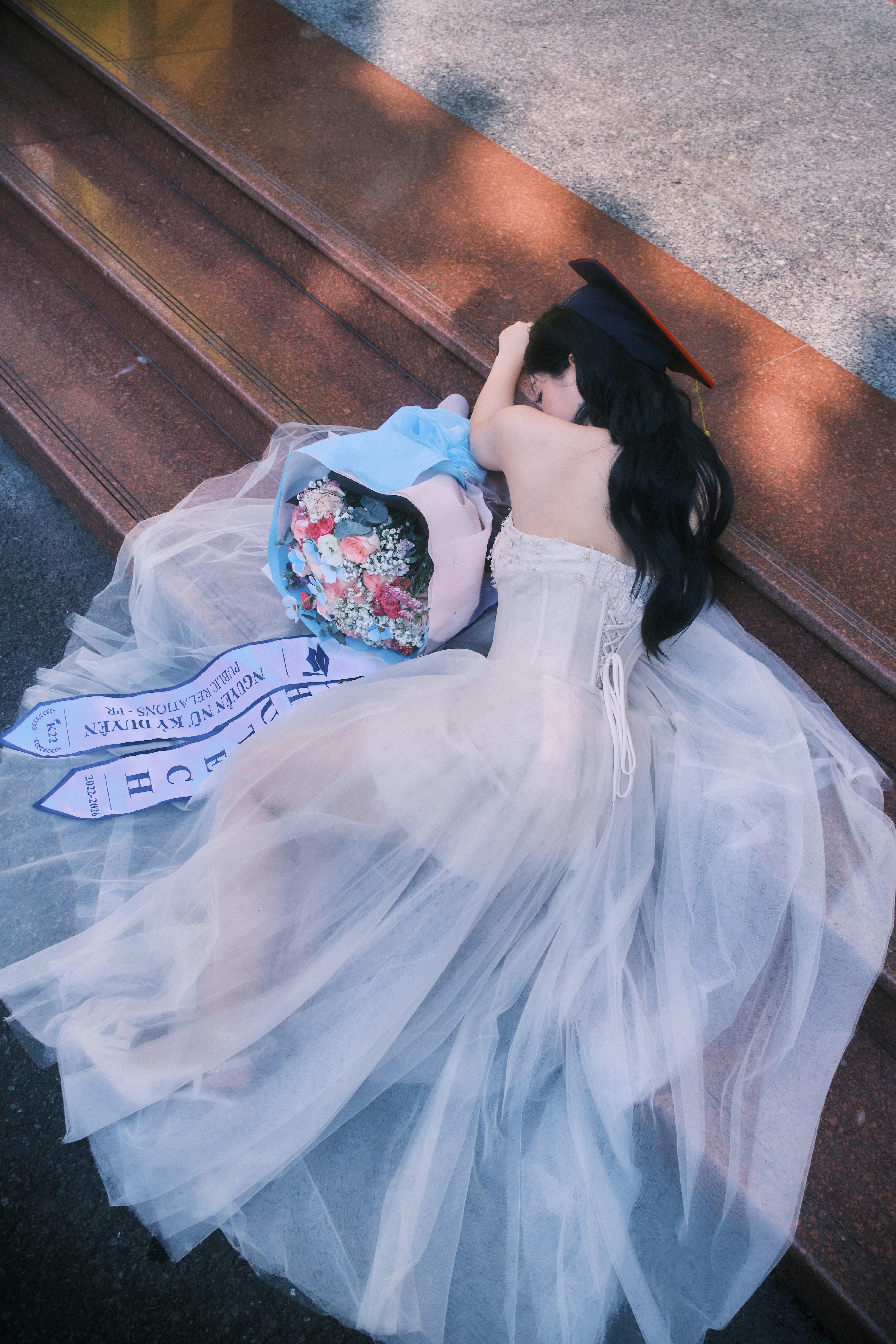 Graduation gown on concrete stairs: a quiet moment after the ceremony
