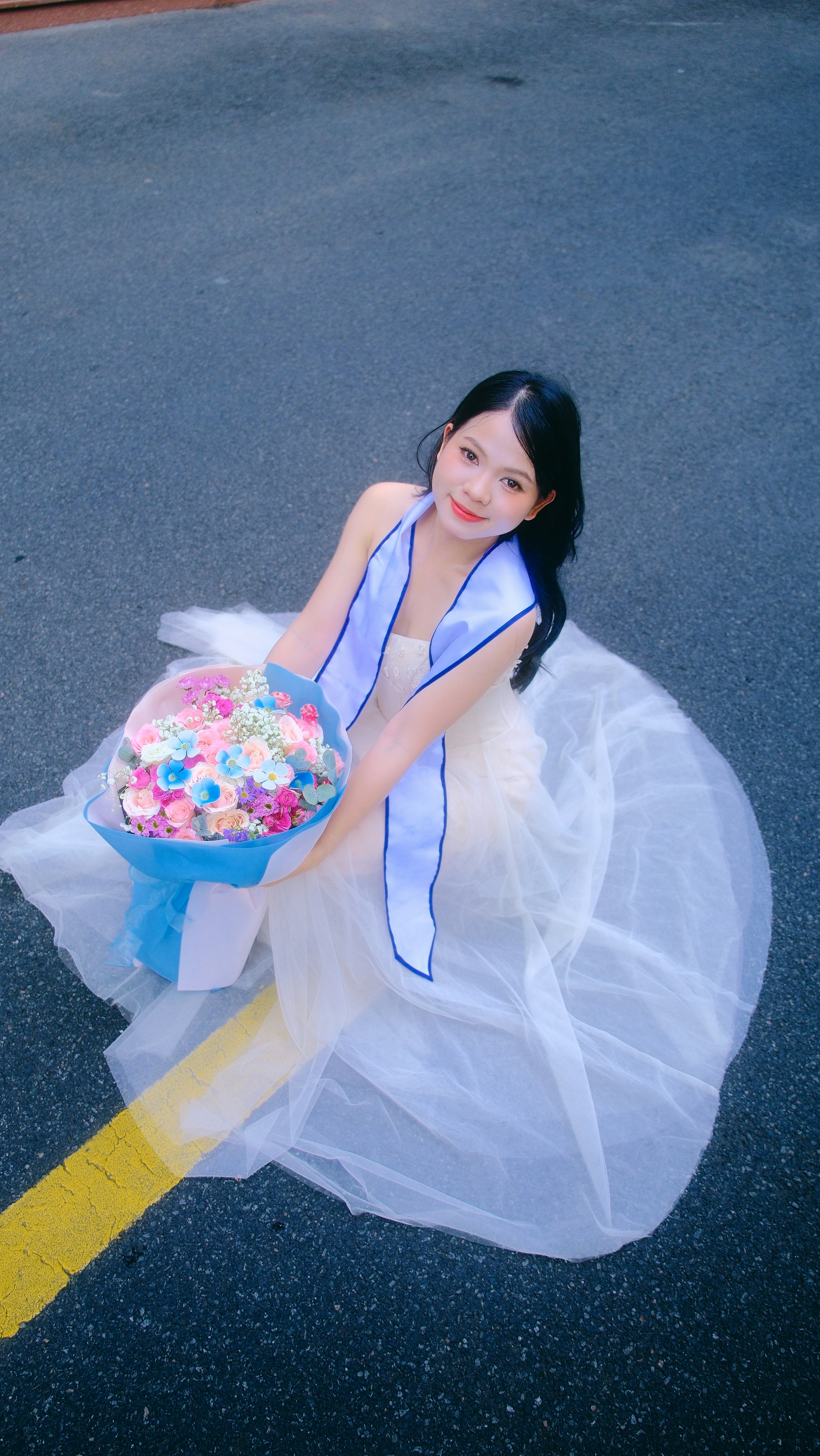 Bride in Bloom: Aerial Portrait with Bouquet on a Painted Lane