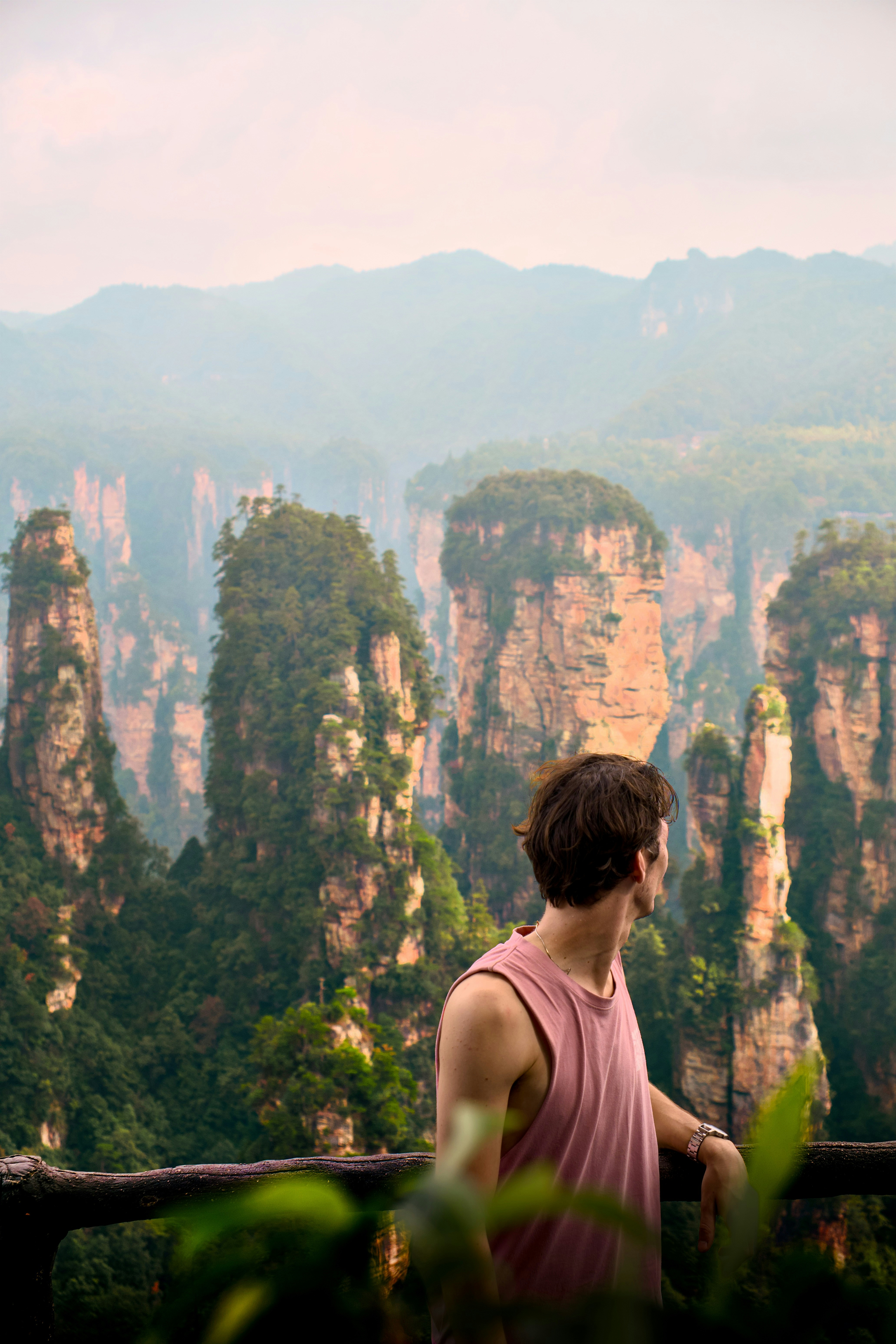 Cliffside Gaze: A Moment Facing the Pillared Vistas