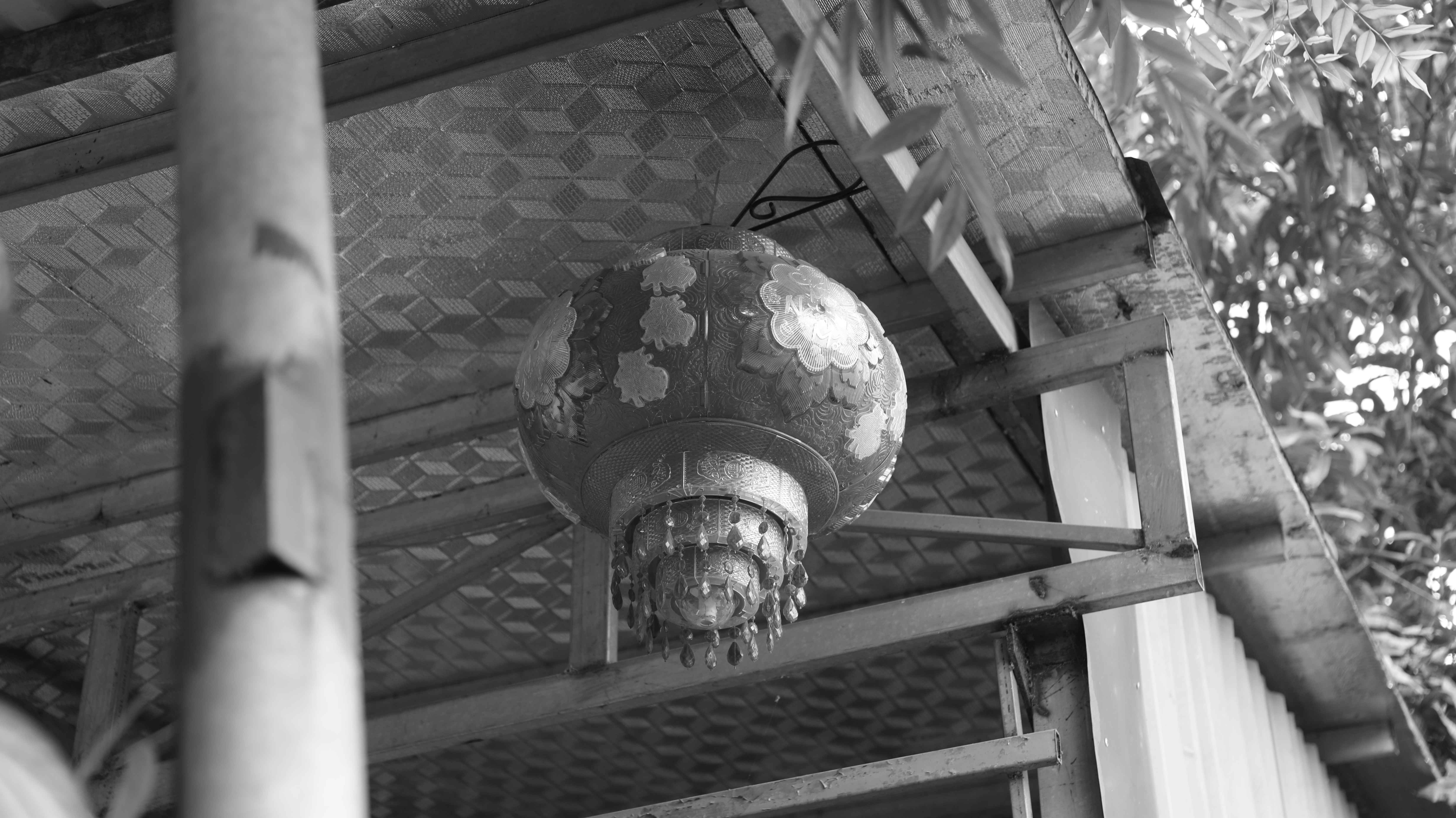 Weathered Lantern Under a Corrugated Roof