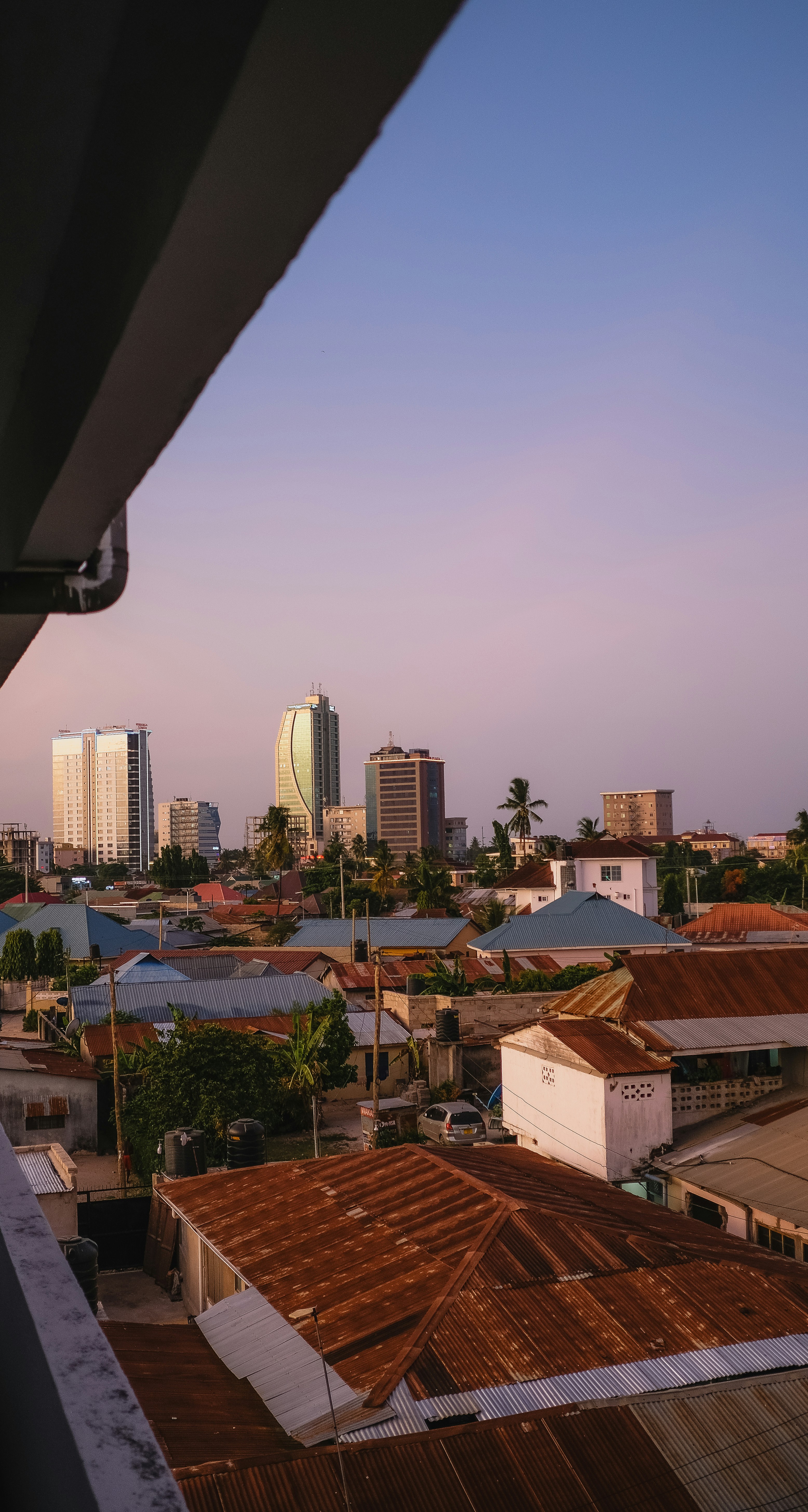 Sunset Over a Rooftop Mosaic of a Coastal City