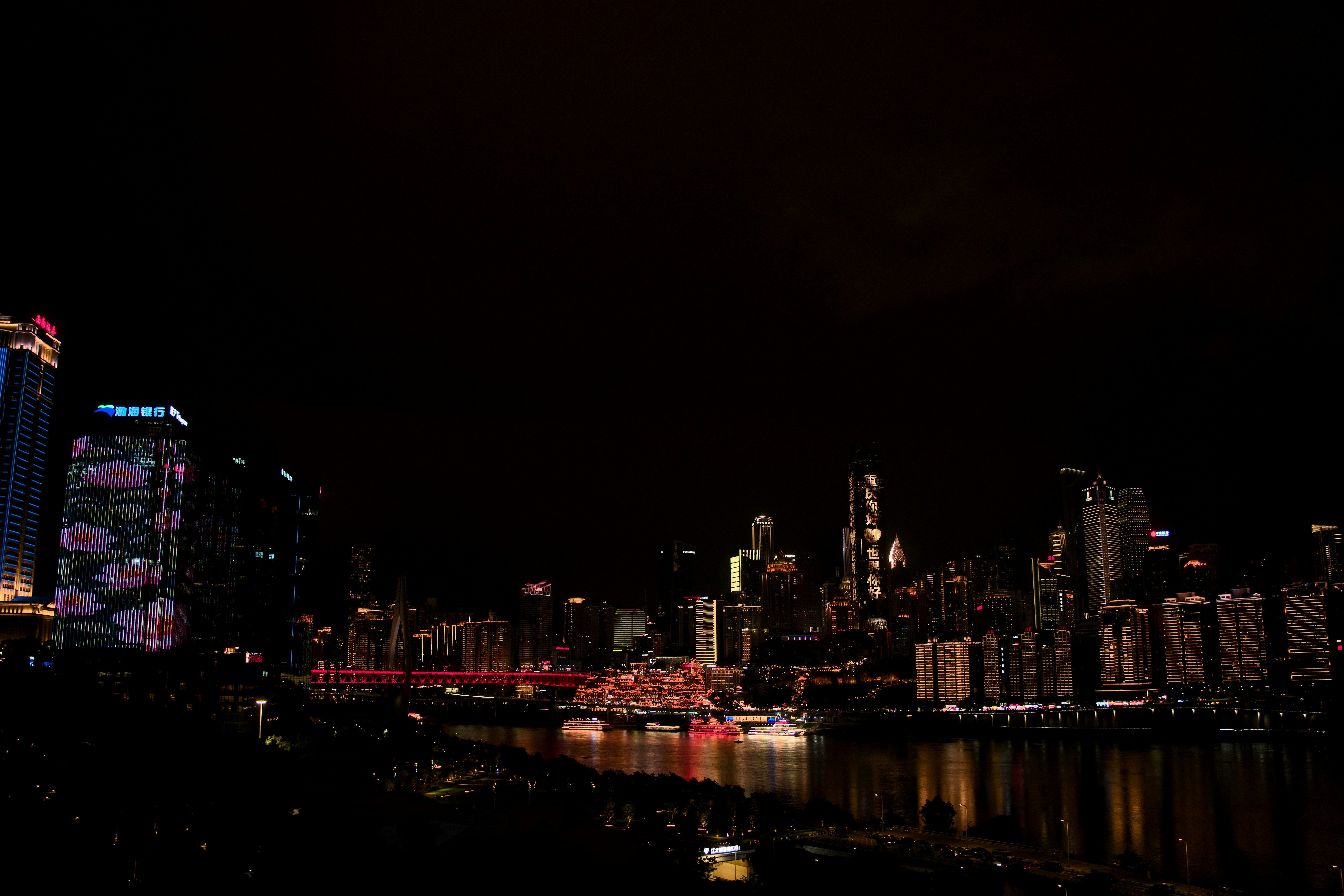 Neon Harbor: Nighttime Skyline Reflecting on Quiet Waters