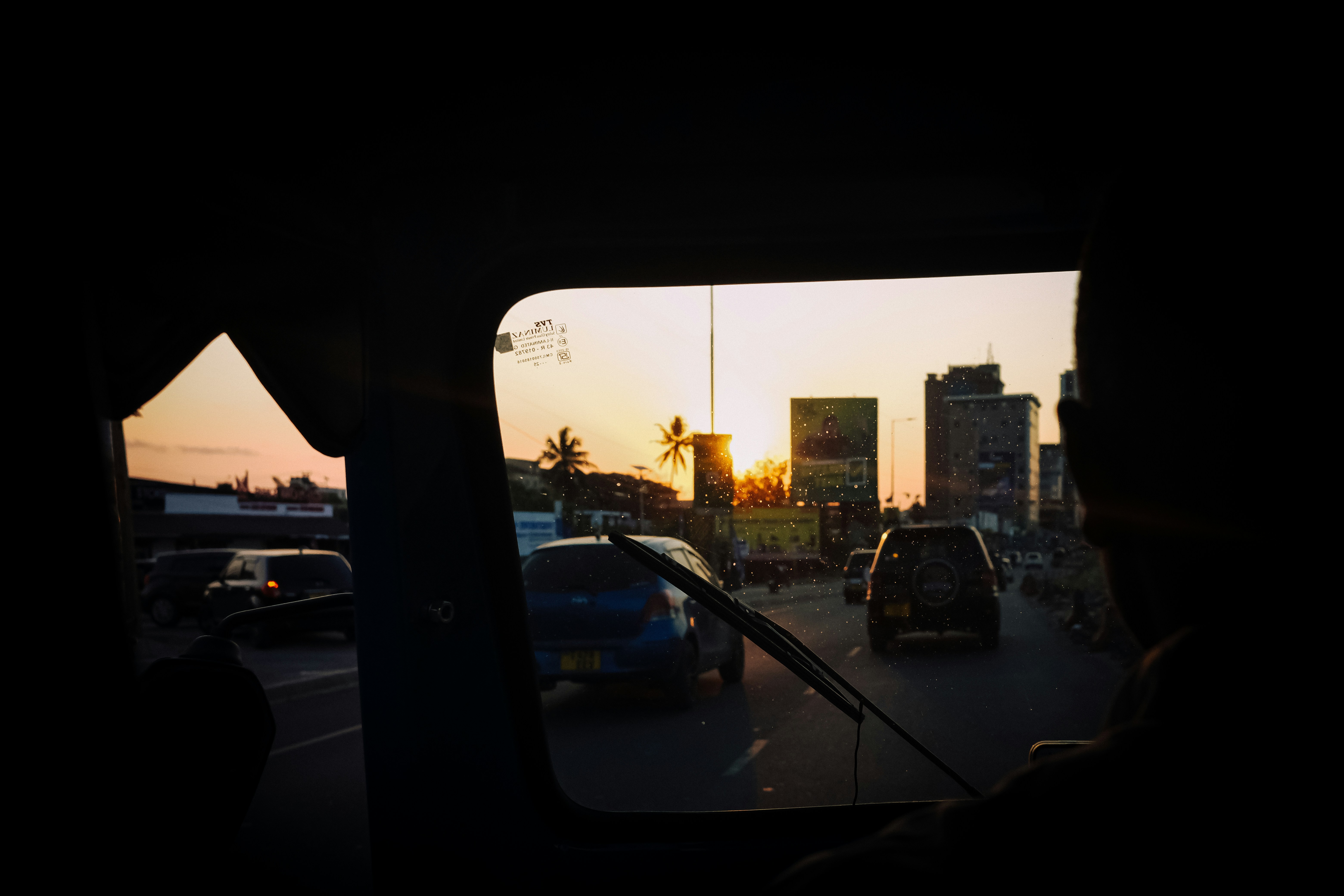 Jammed Window, City Sunset: A Bus Ride Through Backlit Glass