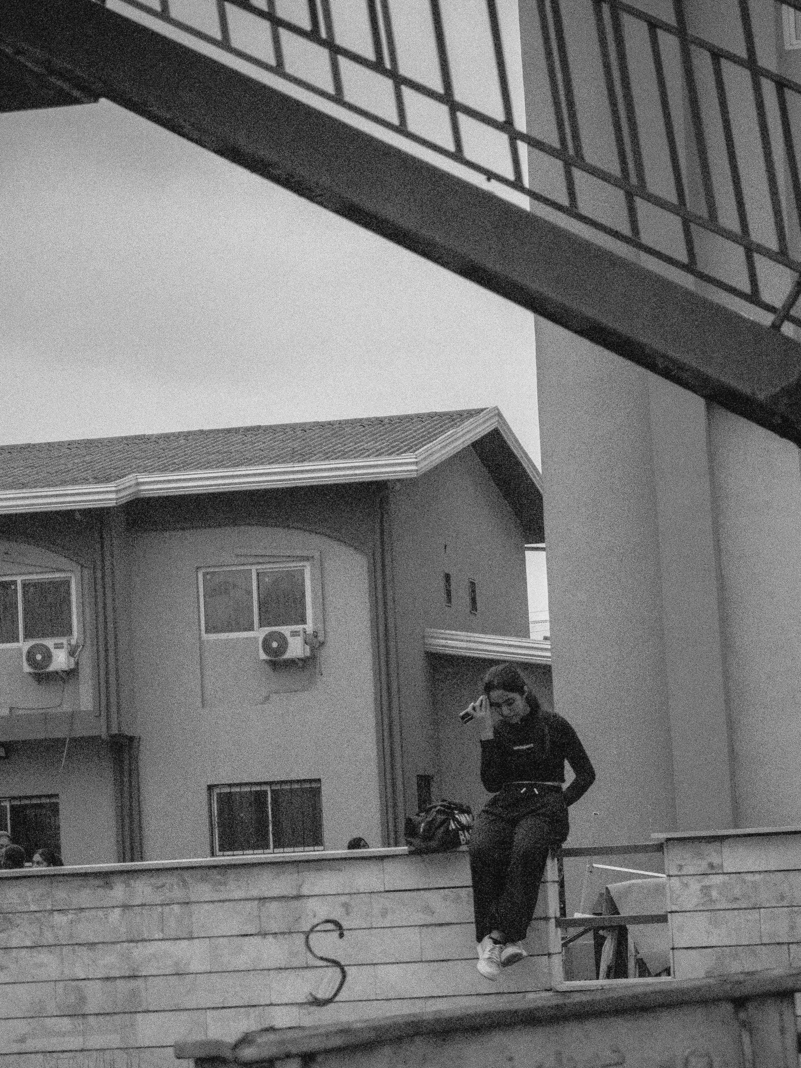 High-Ralley Balcony Quiet: A Solo Figure Overlooking the City Edge