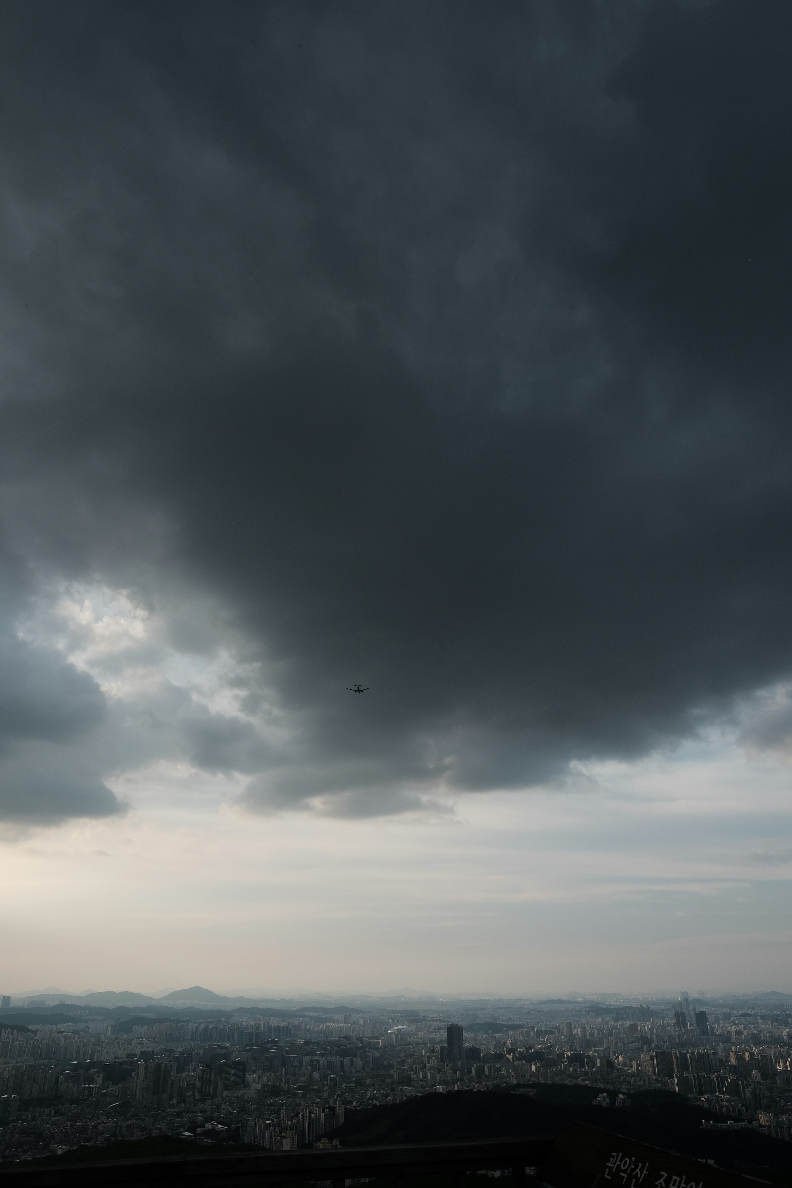Clouds Over the City: A Quiet Horizon Beneath a Looming Storm