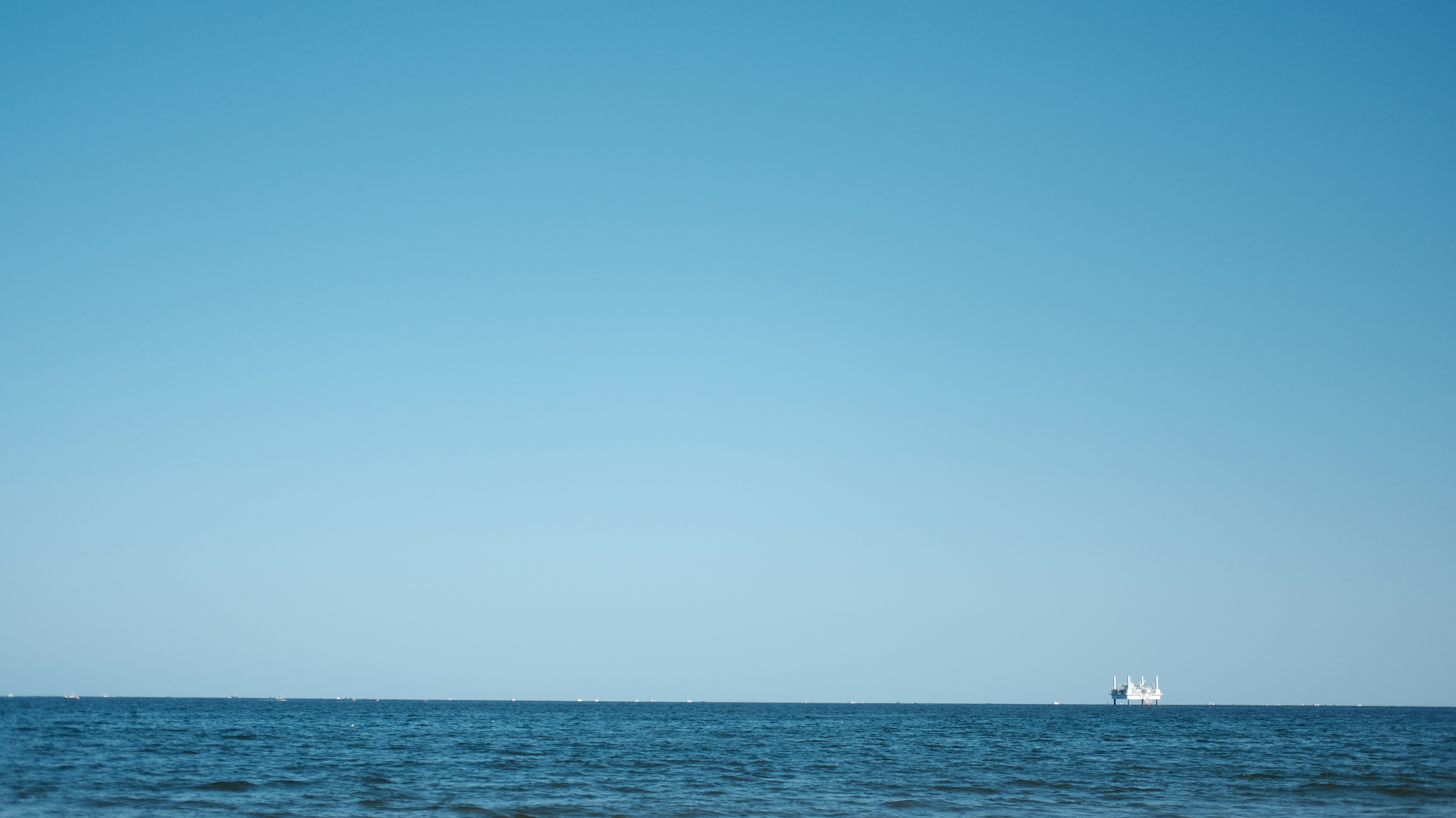 Horizon Quiet: A Distant Vessel on a Calm Sea