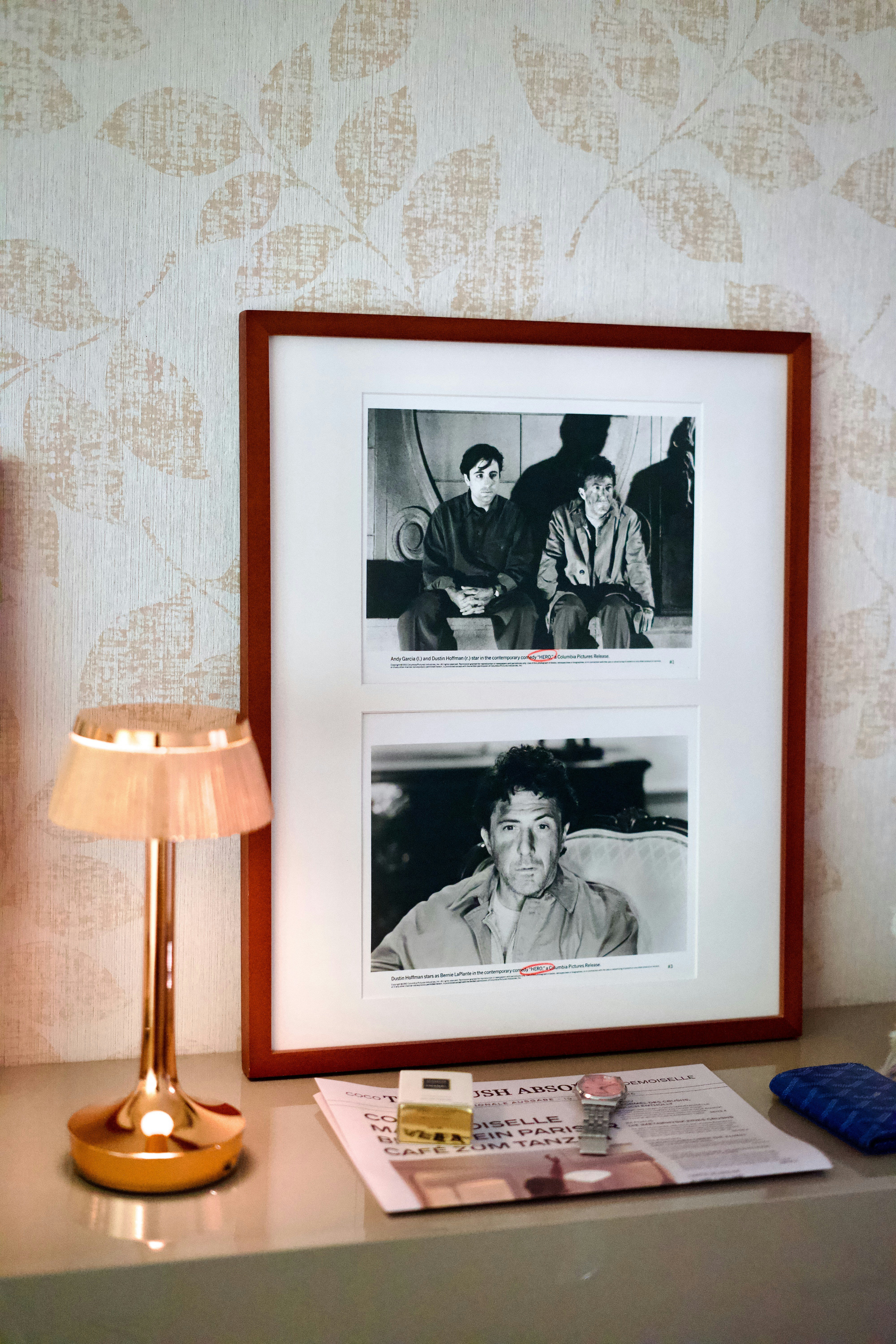 Two Black-and-White Portraits Framed, Resting on a Console