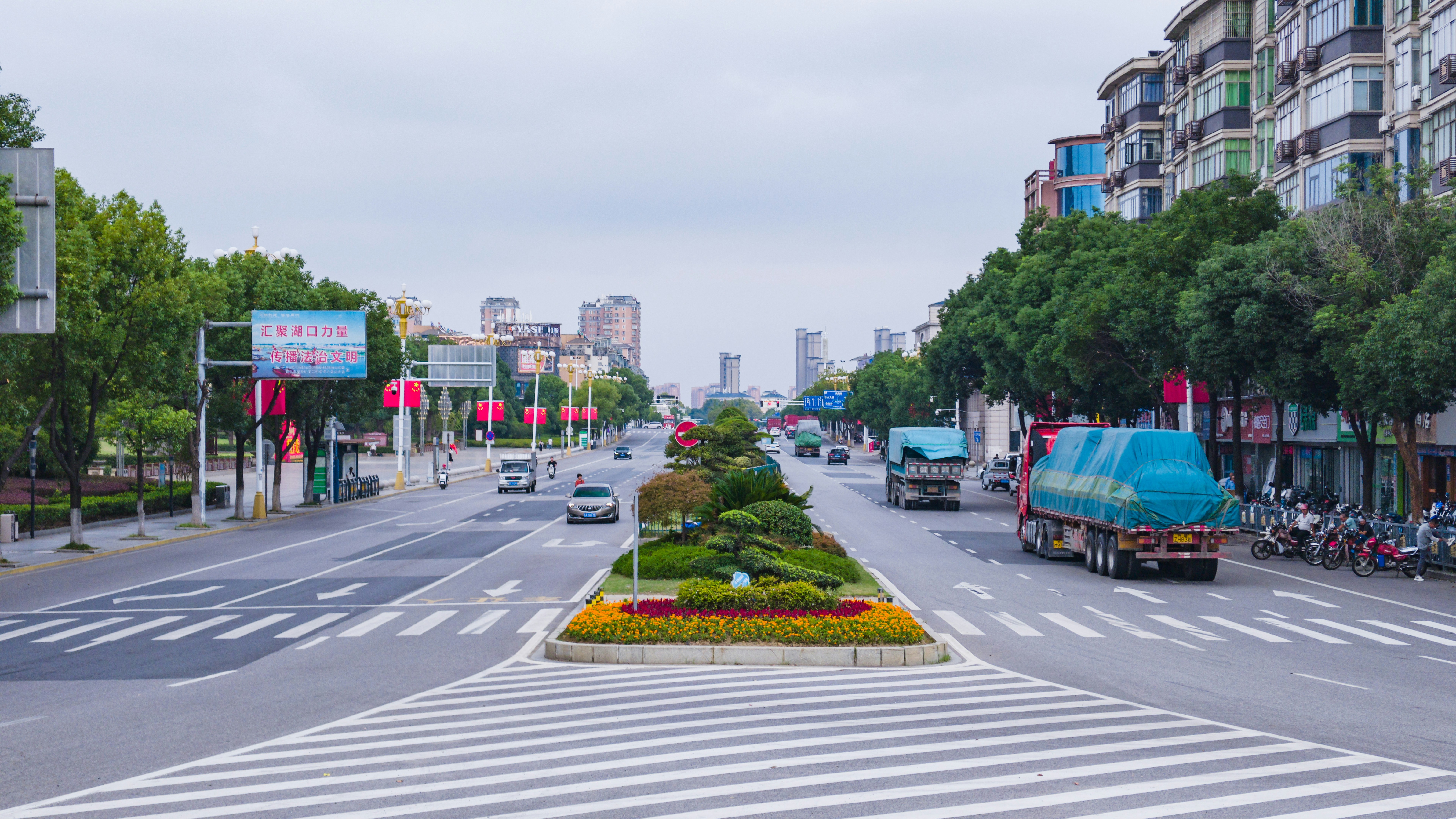 Aerial Boulevard: Centered Green Median Bounded by Cityscape