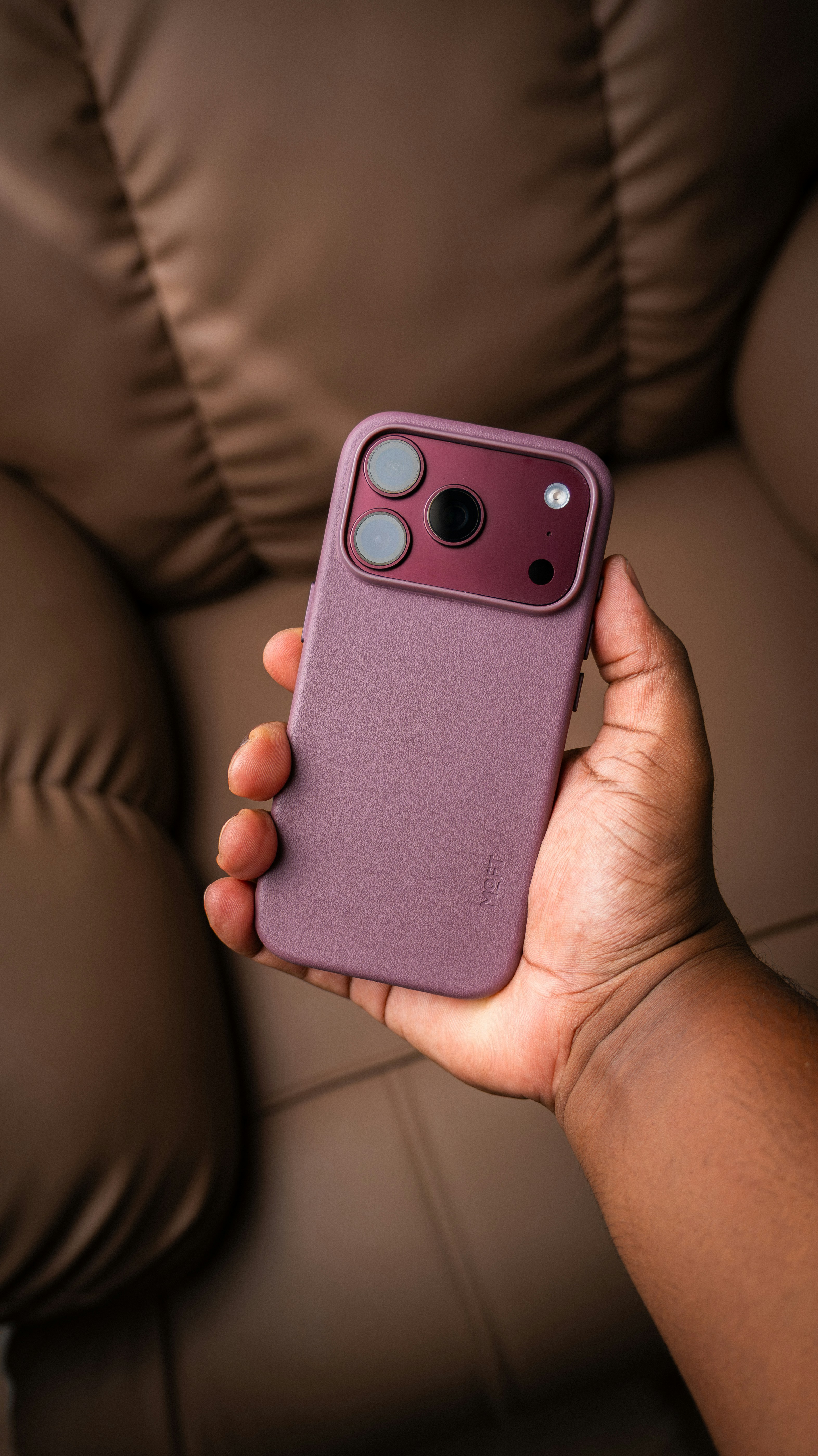 Rosy device in hand: a close-up of a lavender iPhone 13/14 shell cradled by a palm