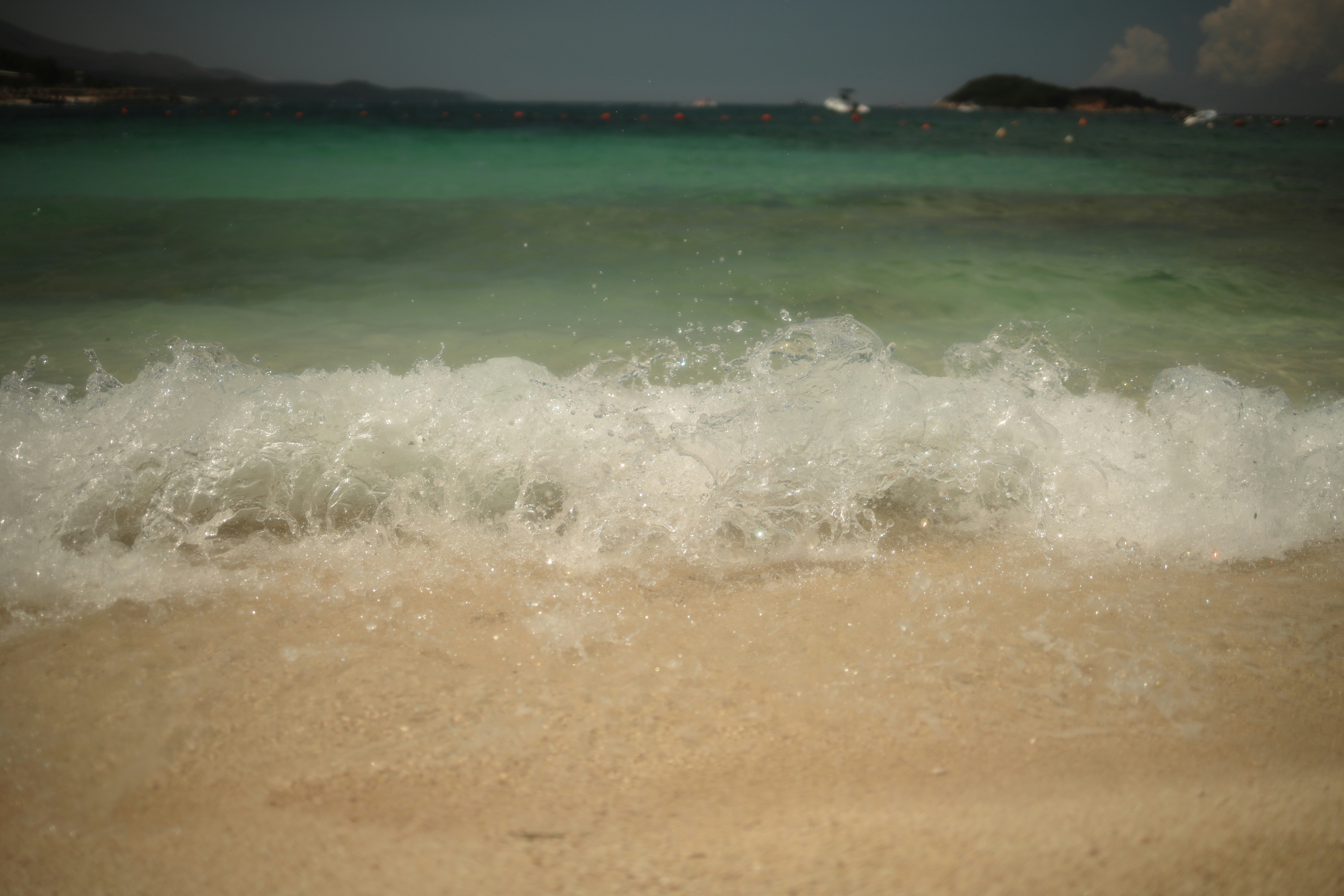 Foamy Crest at the Shore: Sand, Sea, and Light