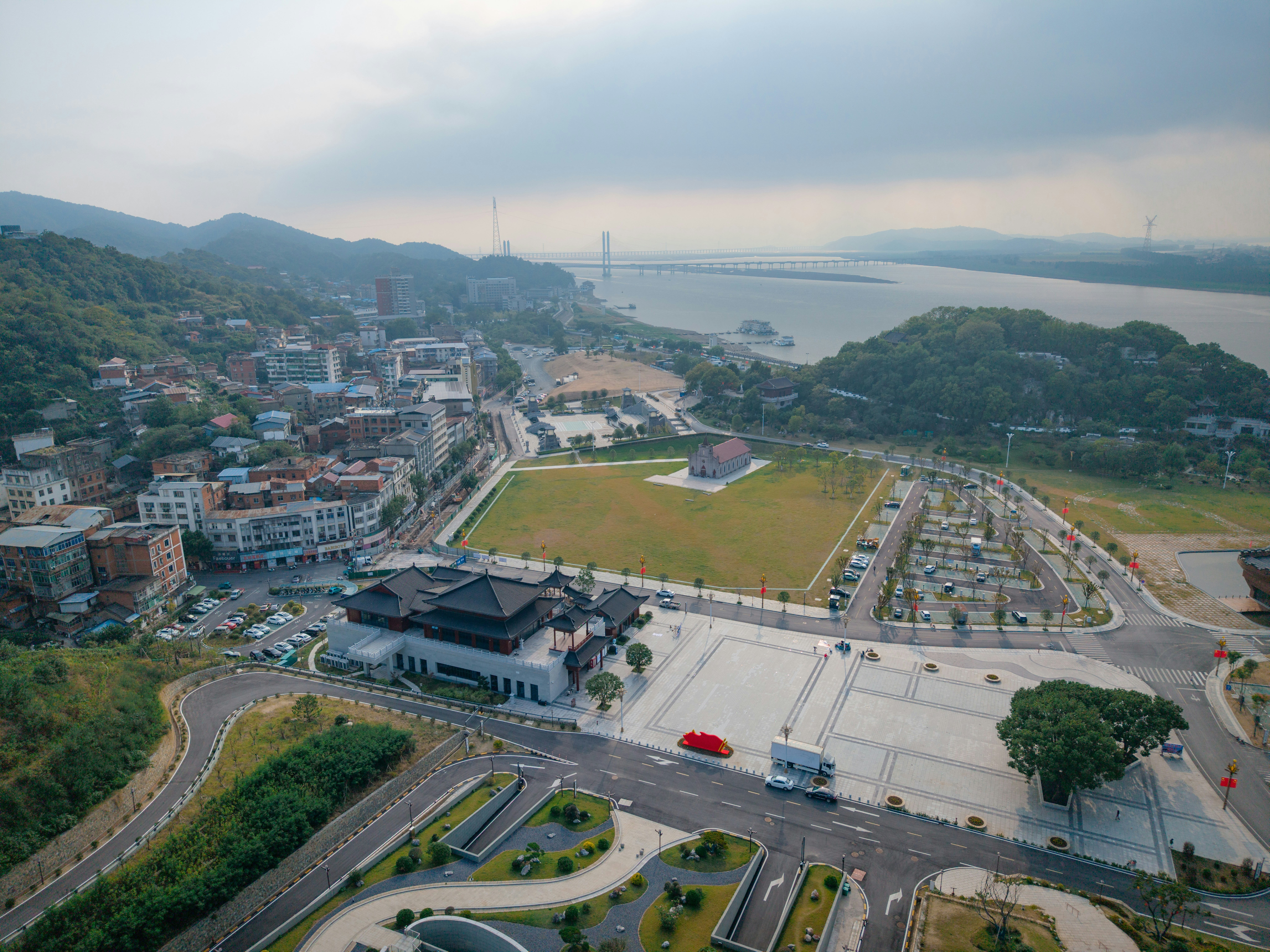 Aerial View of Coastal Town Park and Pier under Soft Evening Light