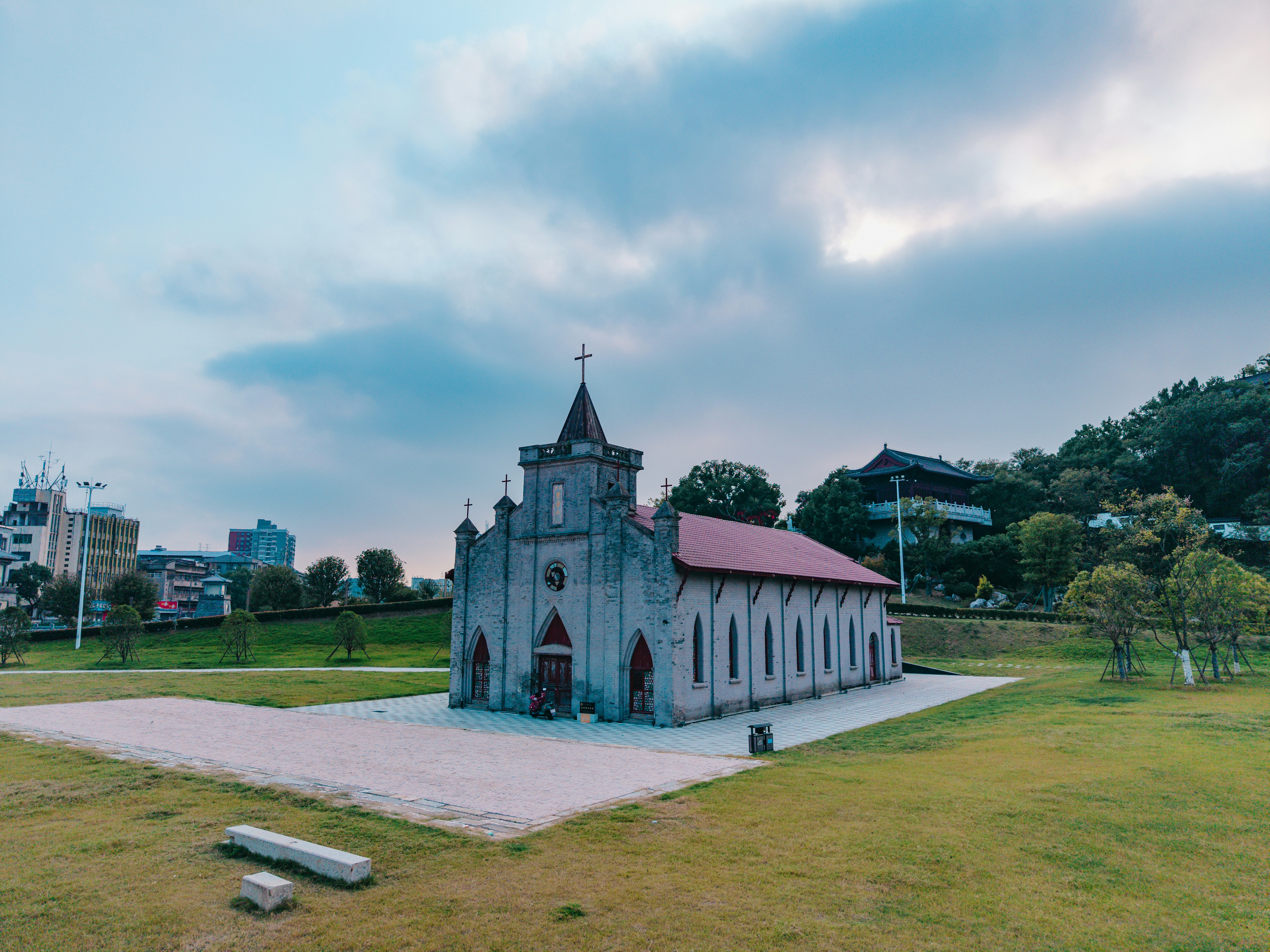 A Quiet Chapel in a Green Campus as Evening Light Begins
