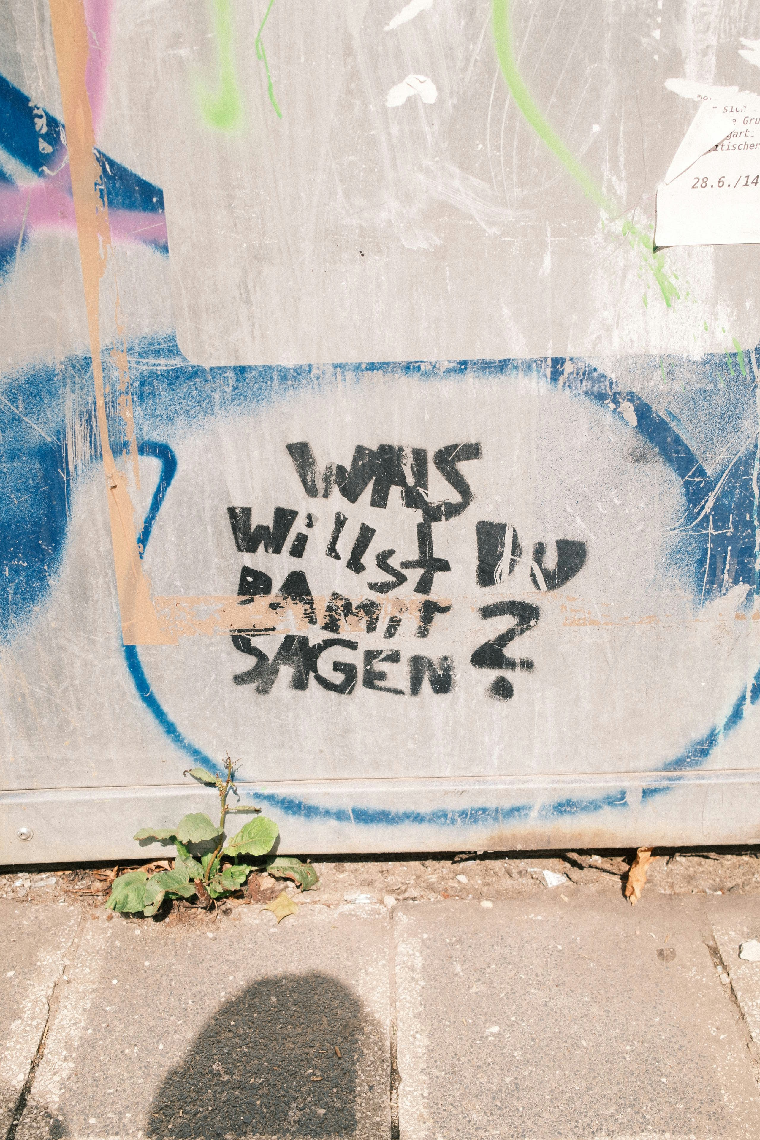 Graffiti Panel with Weathered Message on a Metal Street Surface