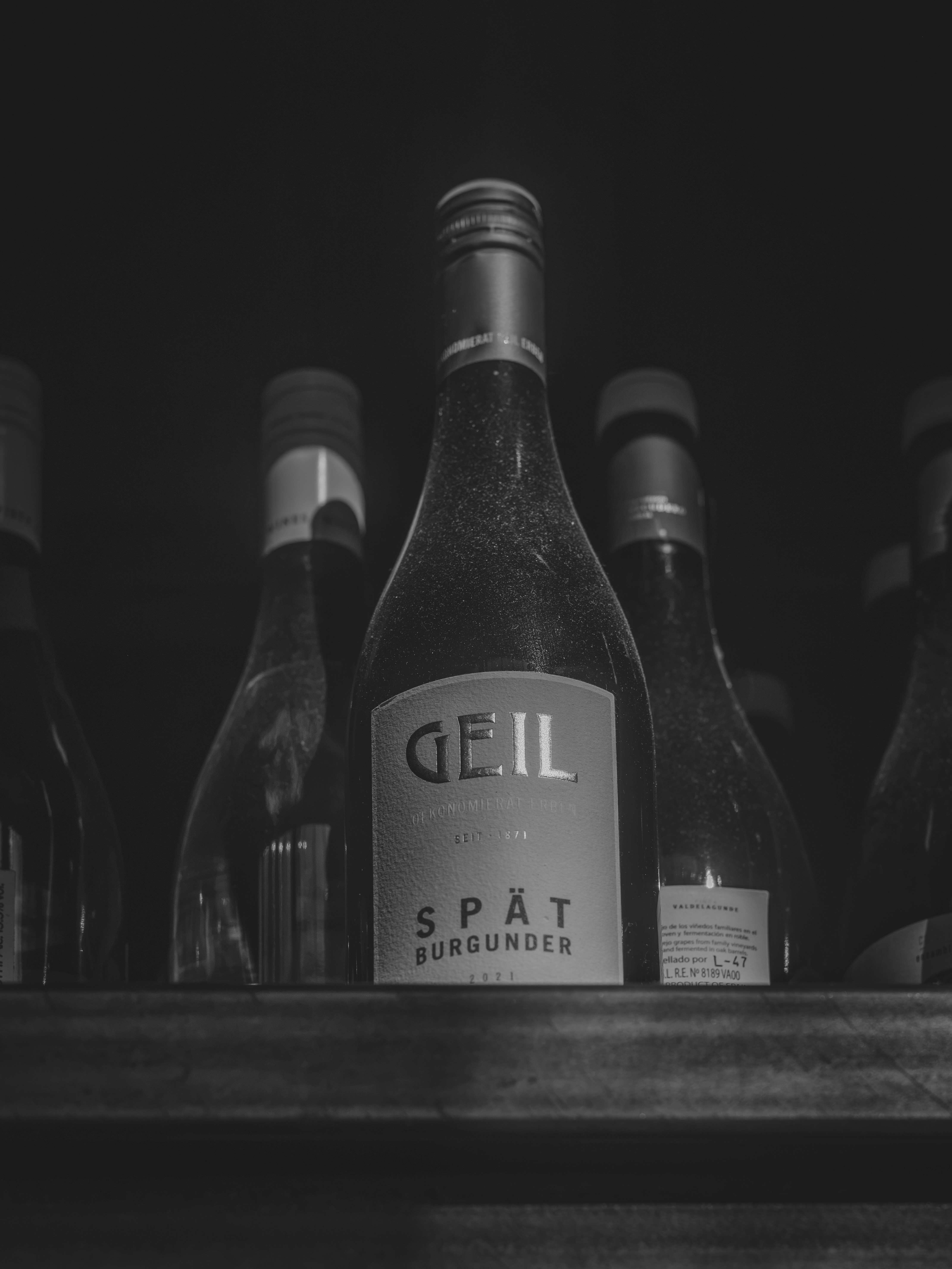 Centered Bottles in a Quiet Shelf: A Close Study of Spät Burgundy in Low Light