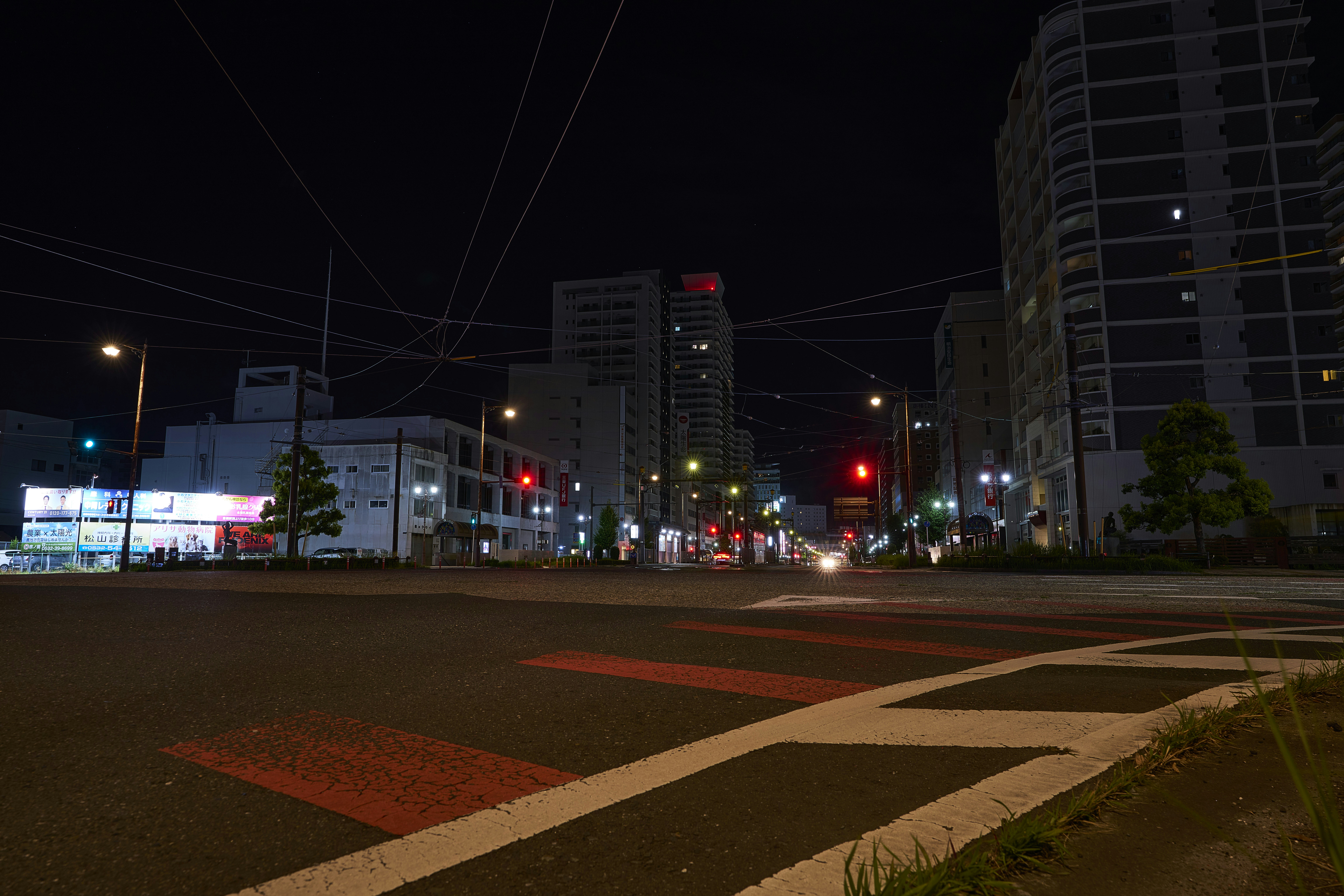 Night Intersection: Neon Veins and Quiet Crosswalk