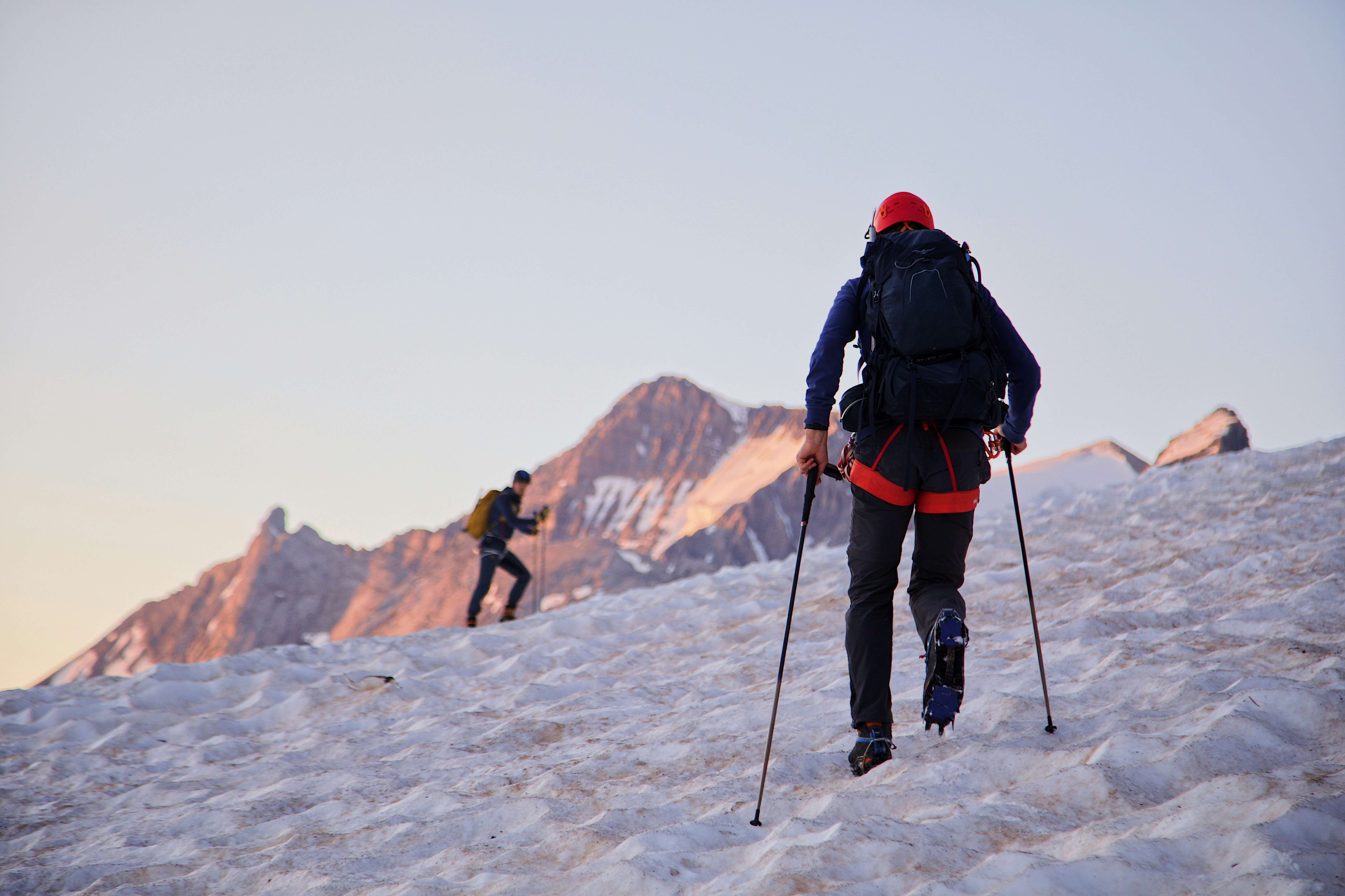 Toward the Ridge: Climber Ascent Under Alpine Light