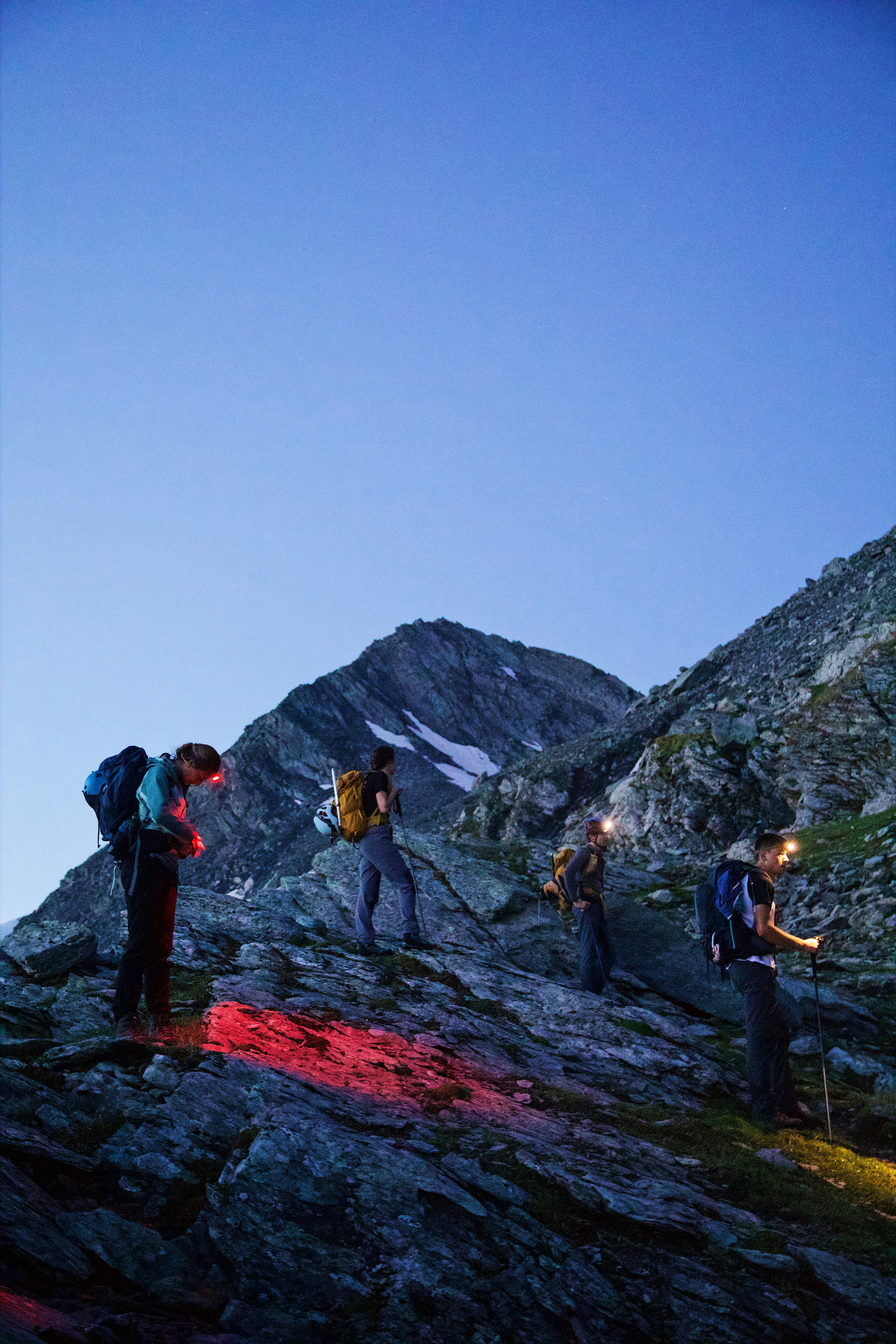 Climbers on a moonlit ridge: a night ascent under starlit sky