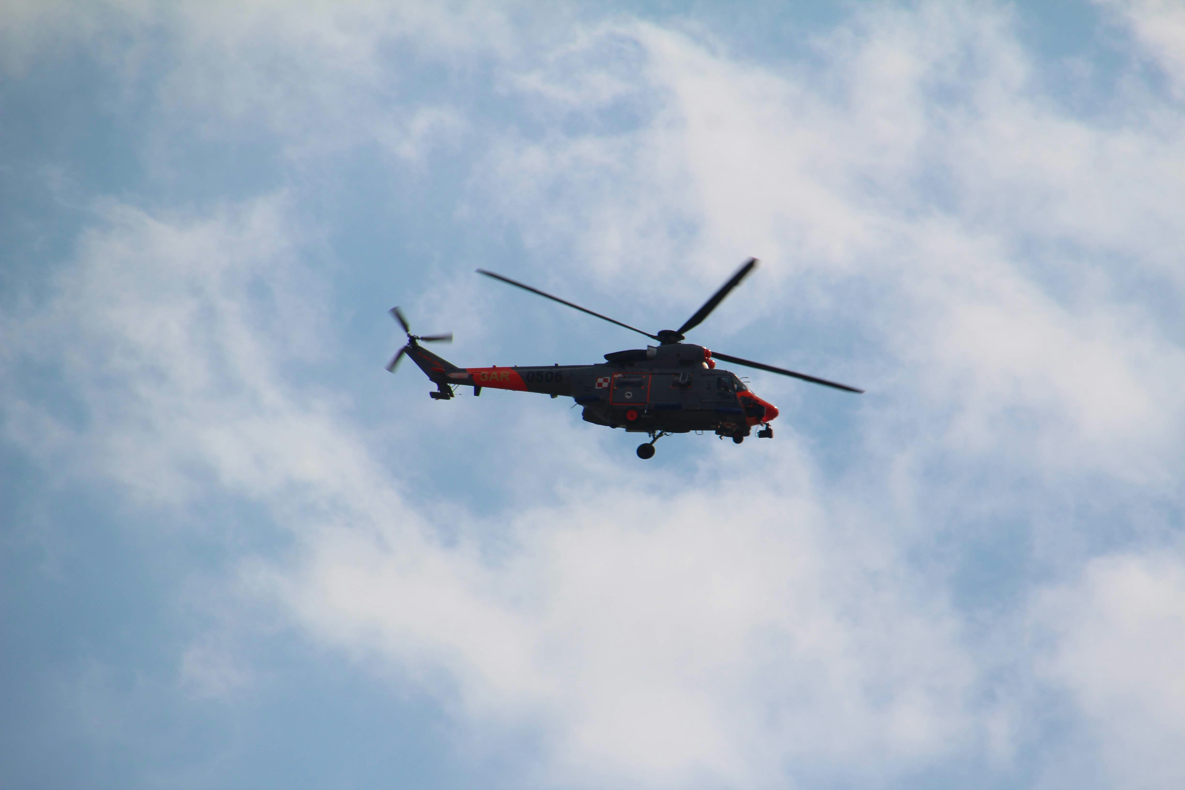Lifted in Blue: A Helicopter Against a Cloudy Sky