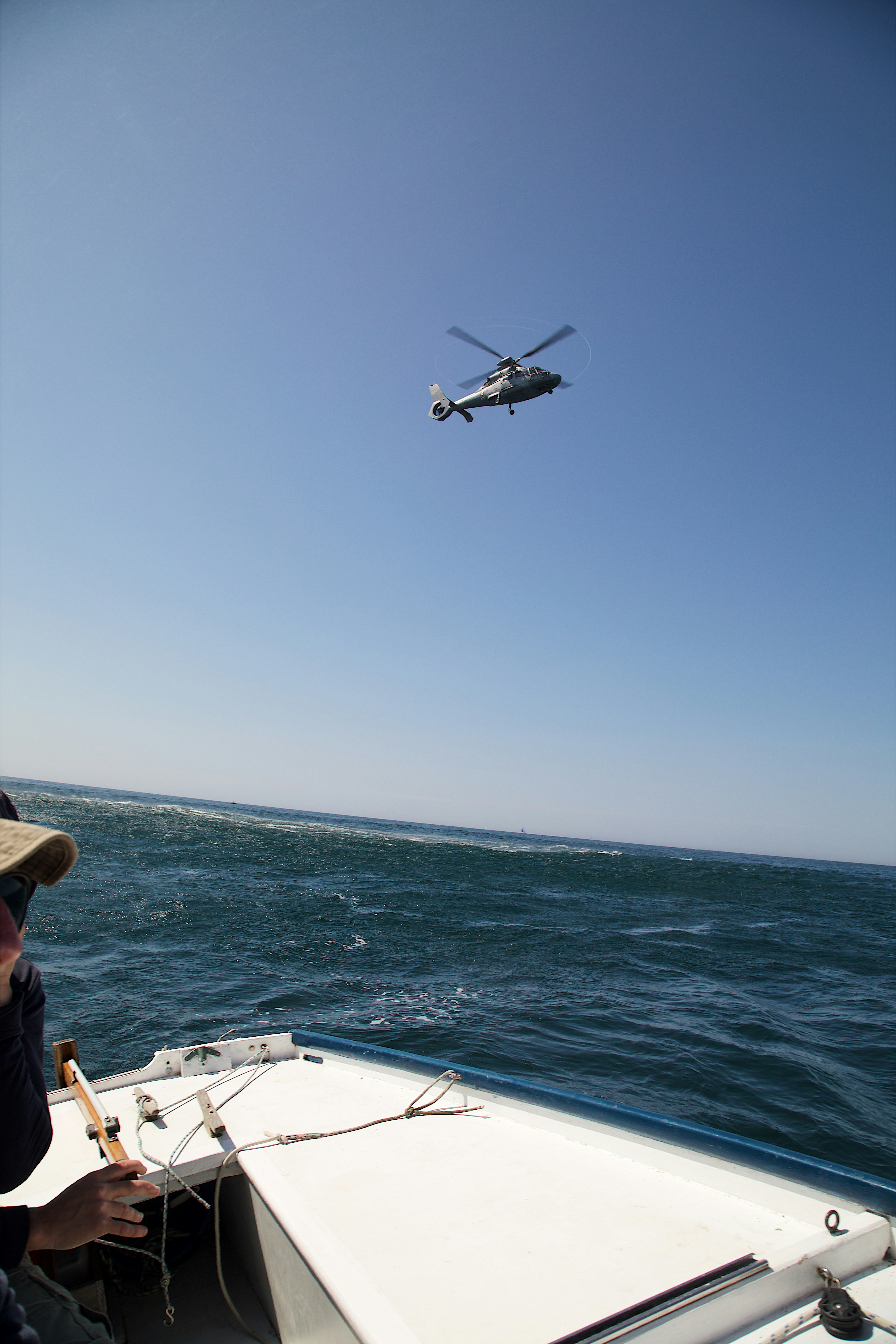 Helicopter Over Ocean: A Quiet Moment of Utility and Sky