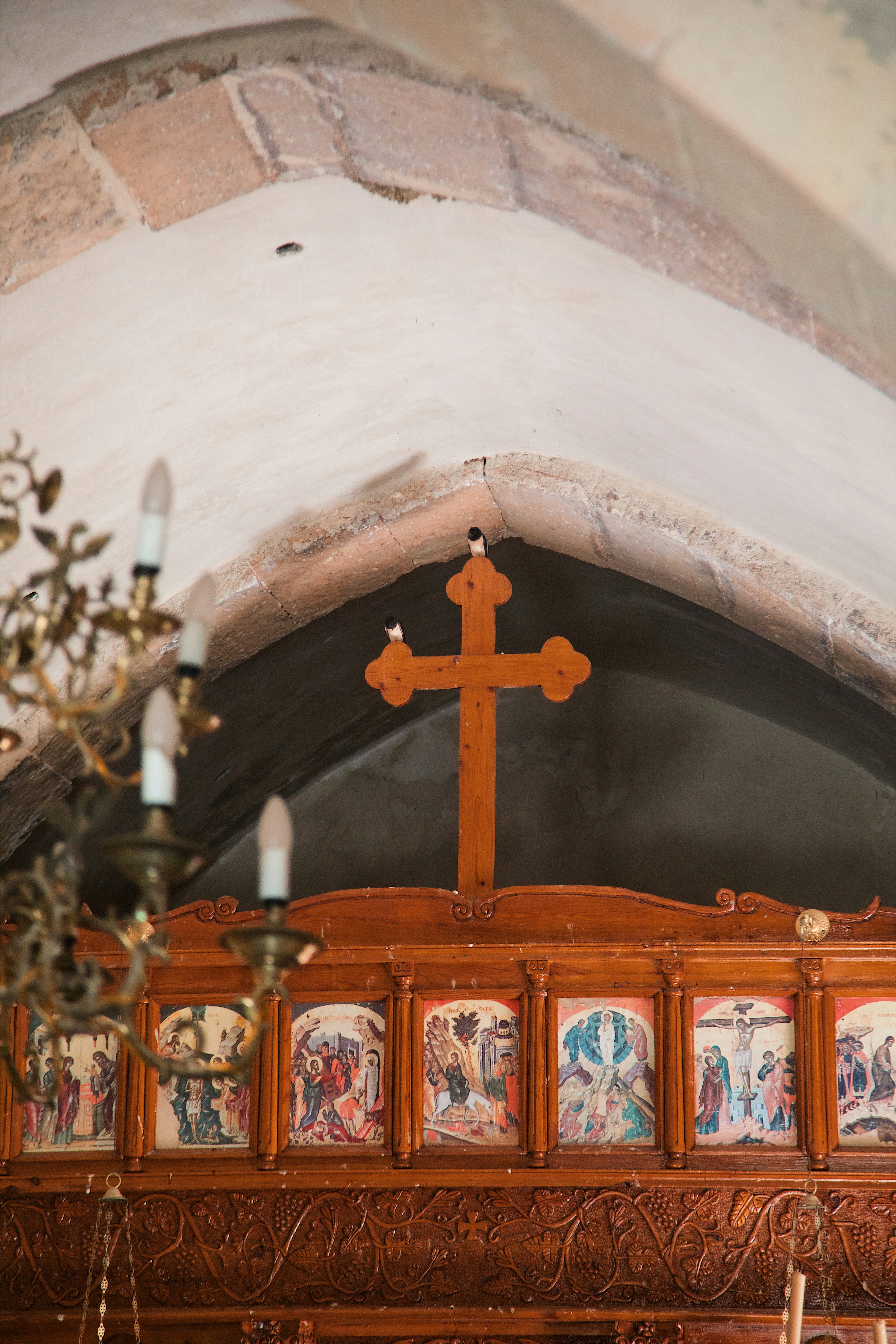 Wooden Christ: A Central Cross Framed by Arch and Carved Panels