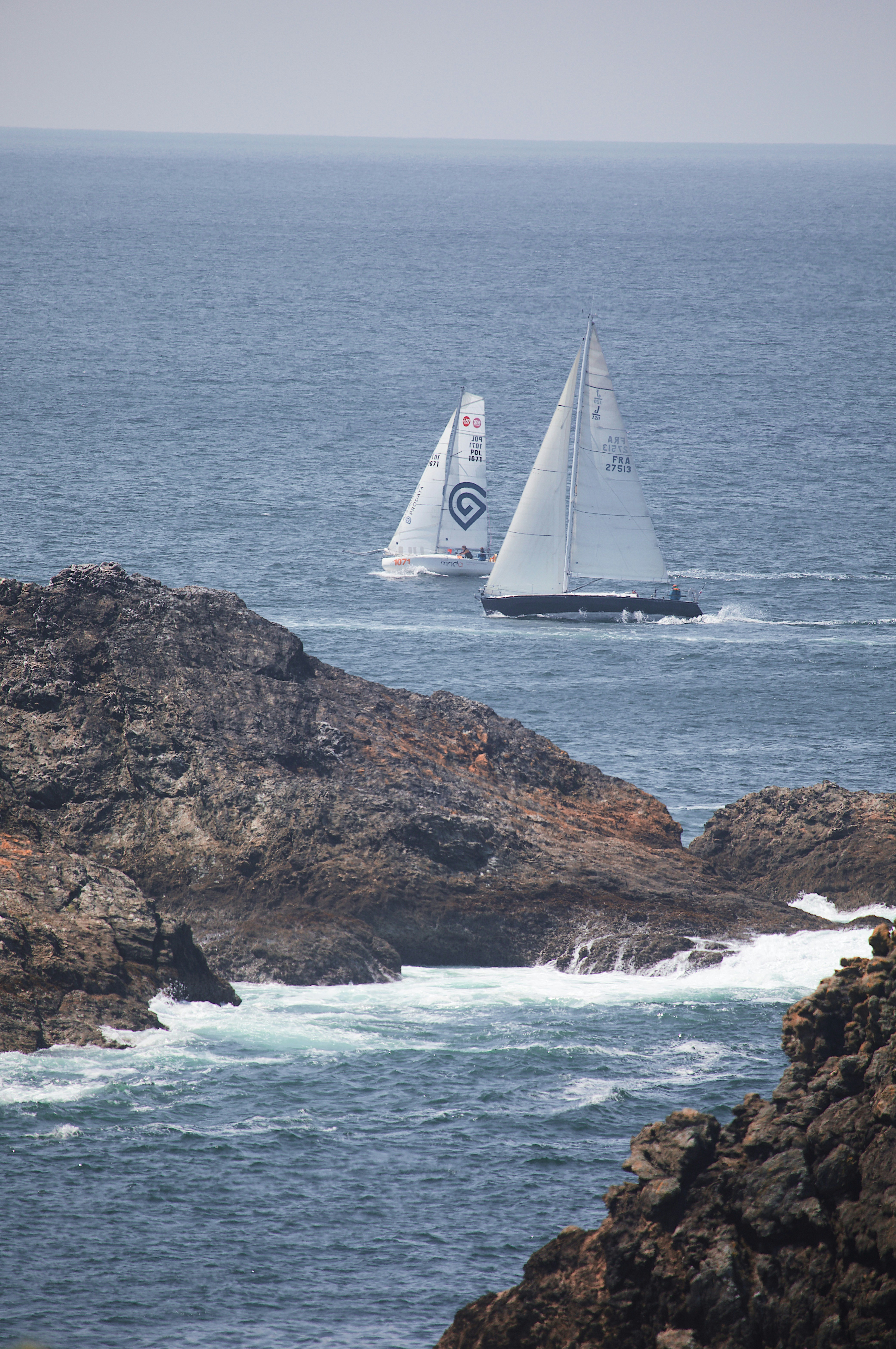 Sailboats Navigating Rough Coastal Light
