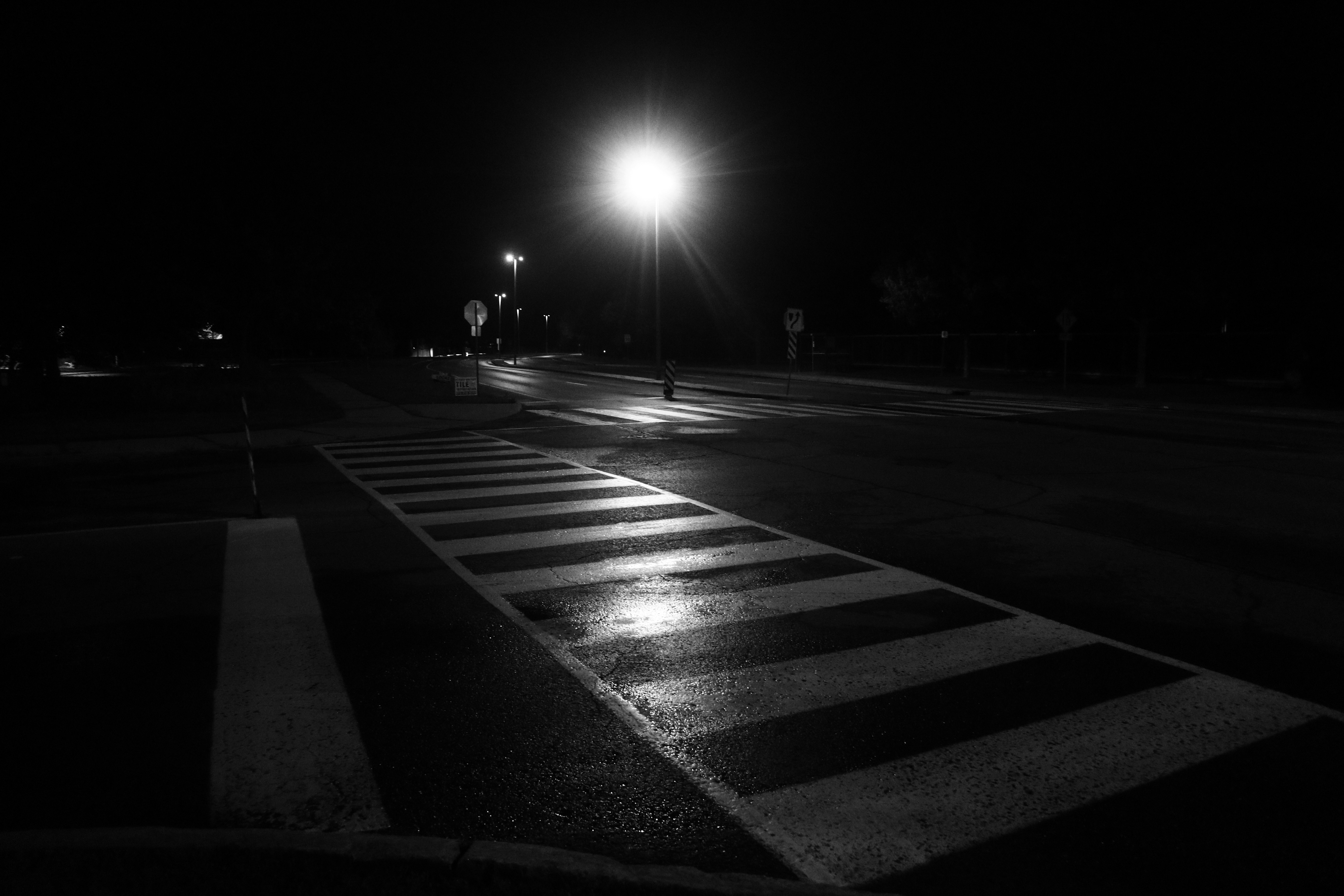 Night Crosswalk Under a Lone Street Lamp