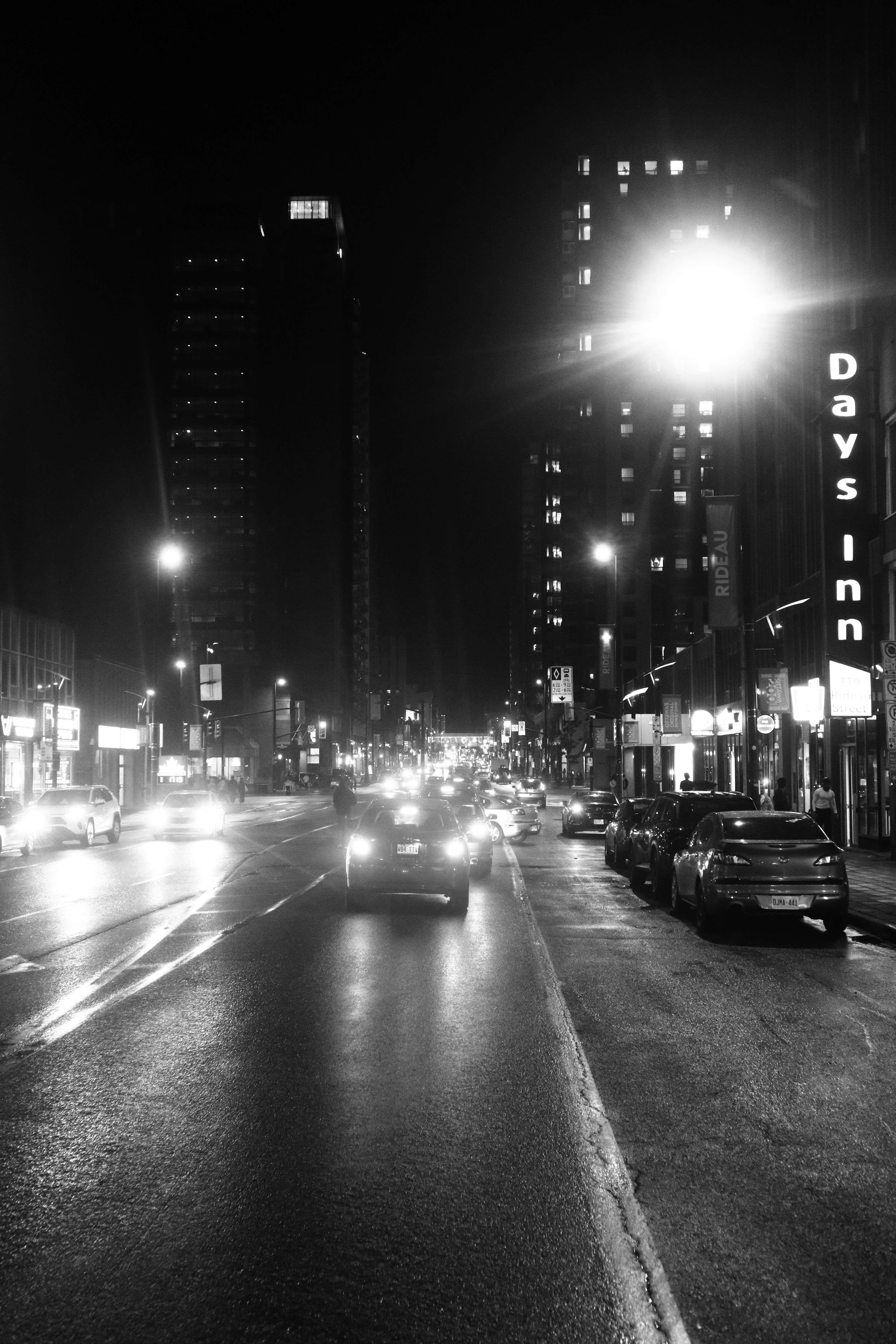 Neon Street Pulse: Night Traffic through a Bright Corridor