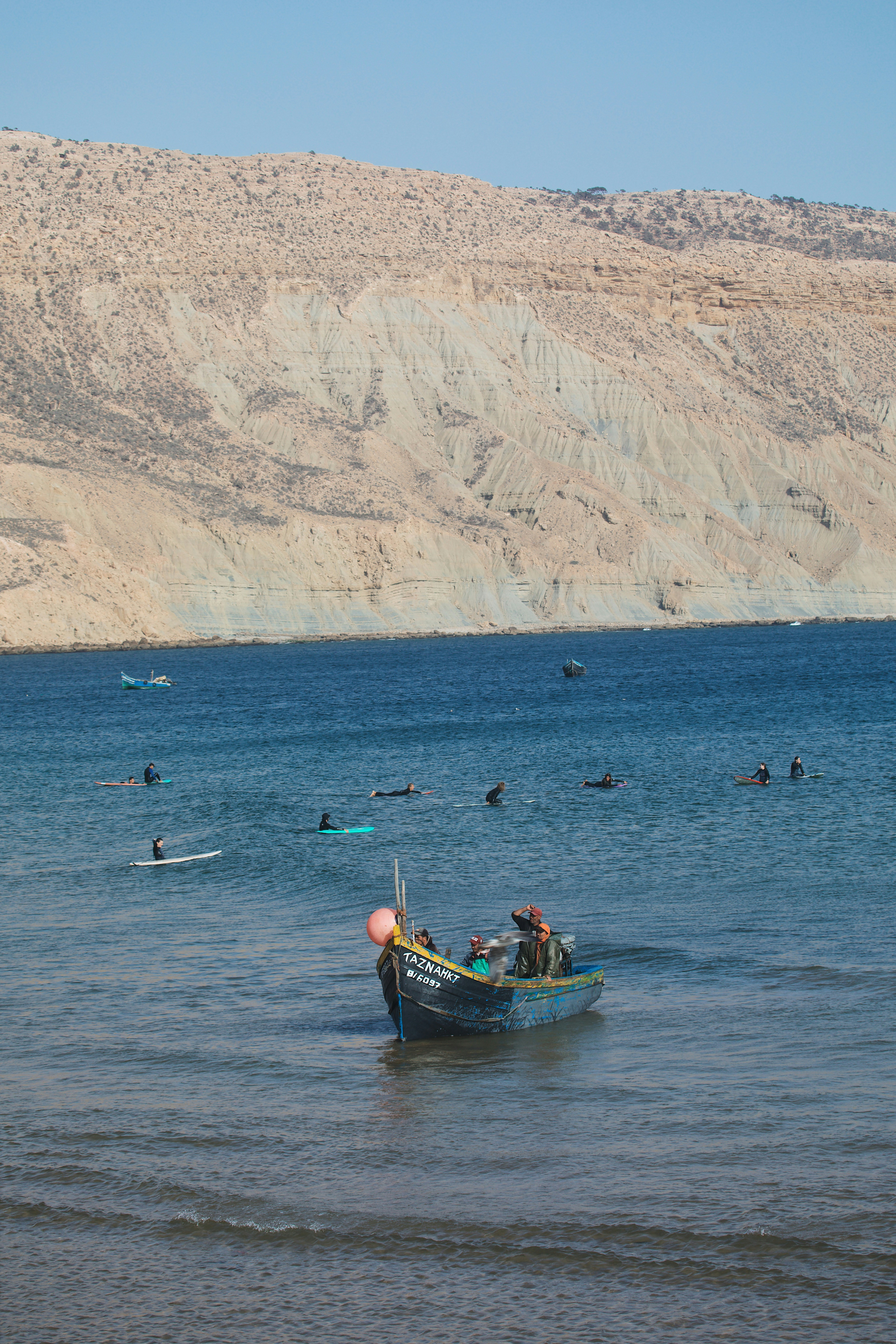 Boat at the Shallow Edge: Quiet Offshore Life Near Desert Cliffs