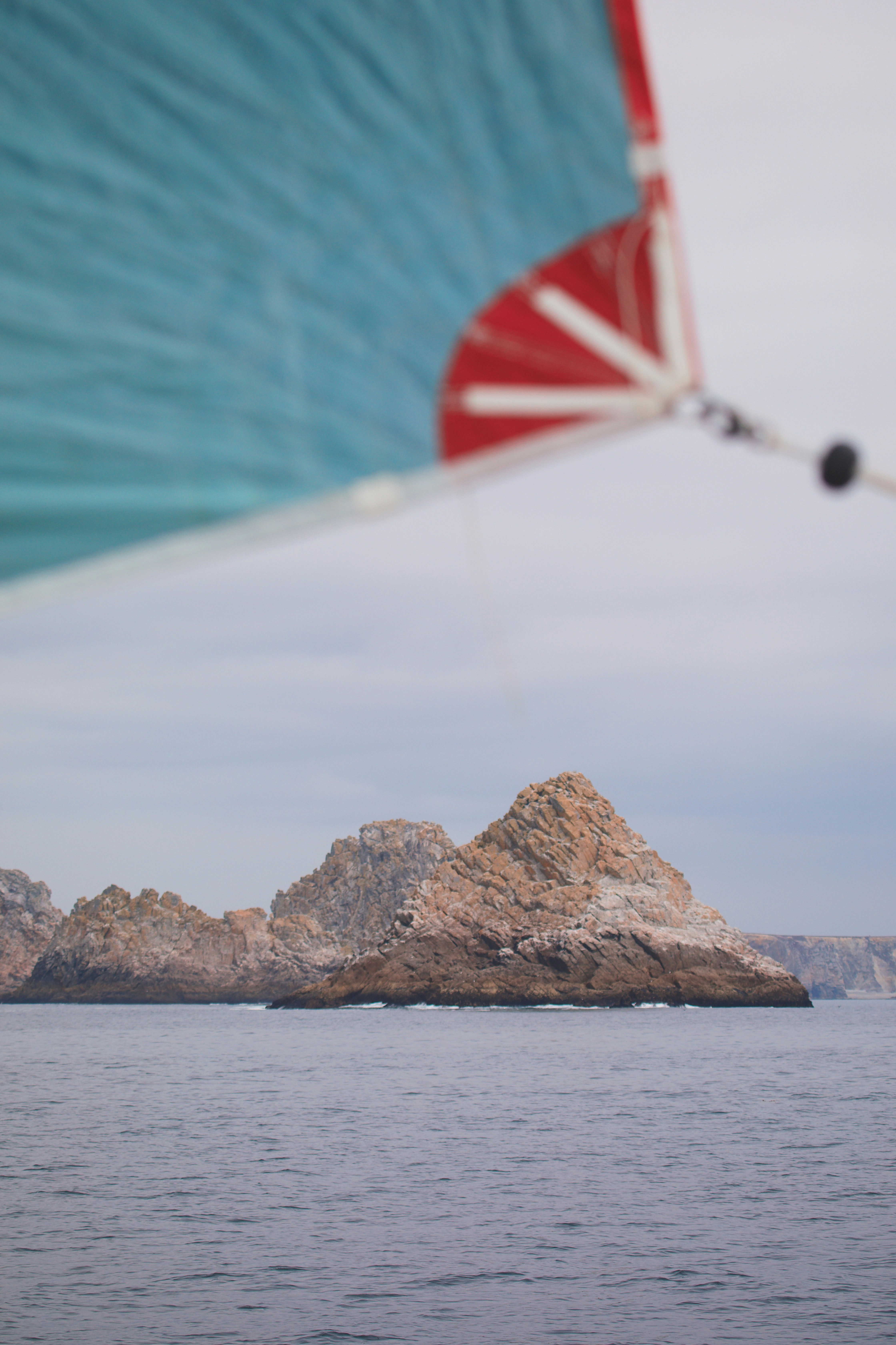 Bow of a Wind-Tossed Sail: A Quiet View of Sea and Rock