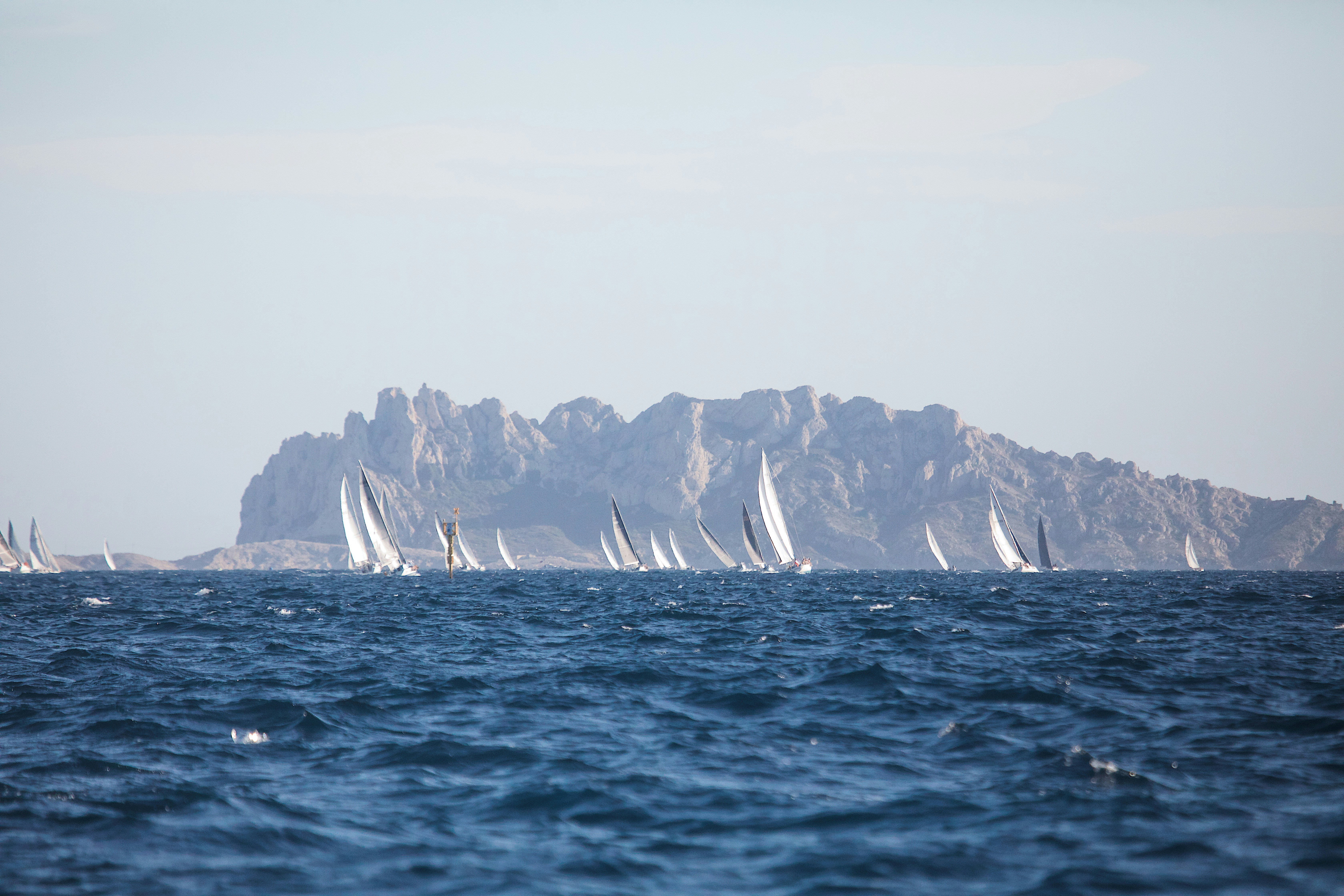 Sailboats at a Distant Cliff