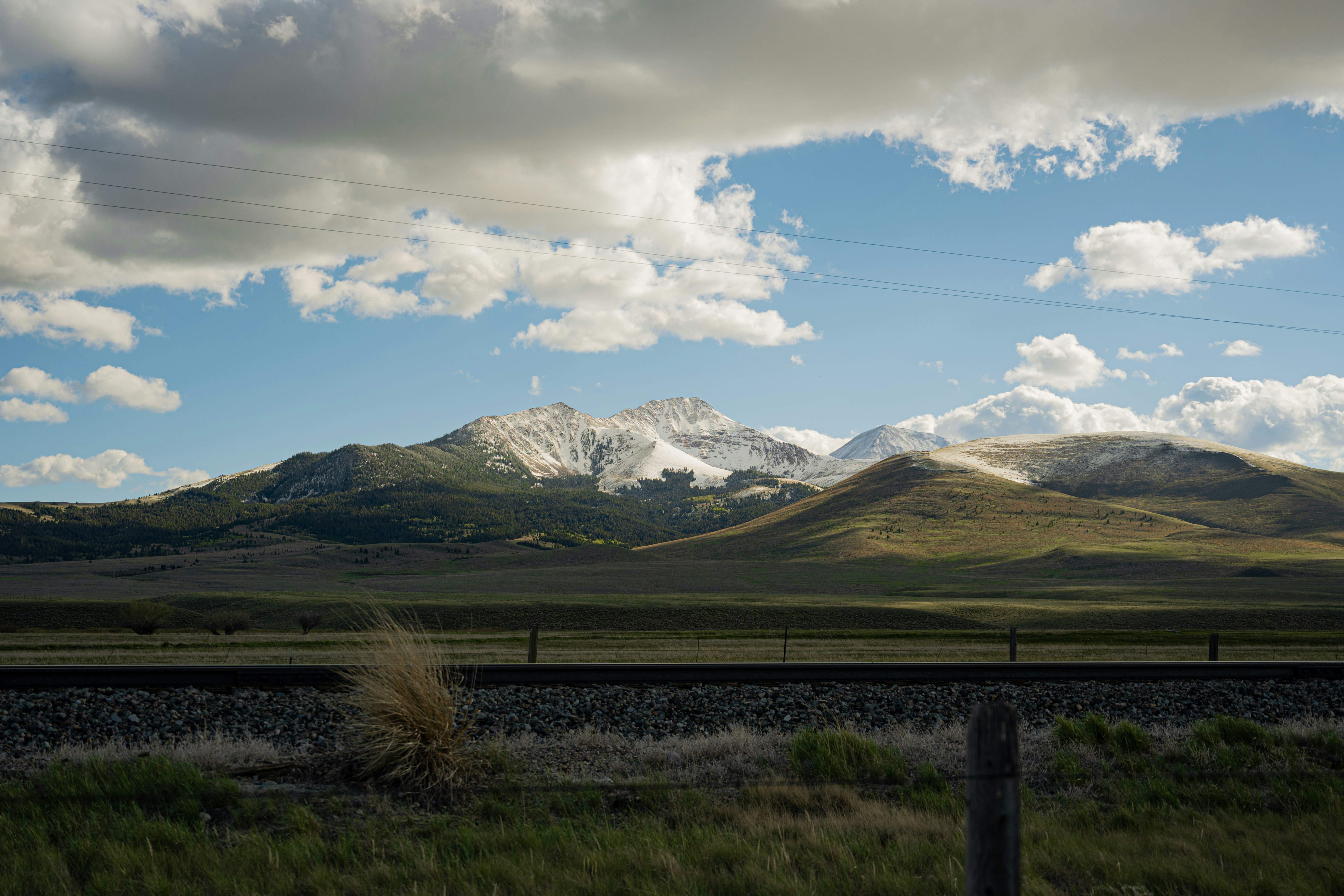 Snow-kissed Peaks above a Quiet Rail Verge