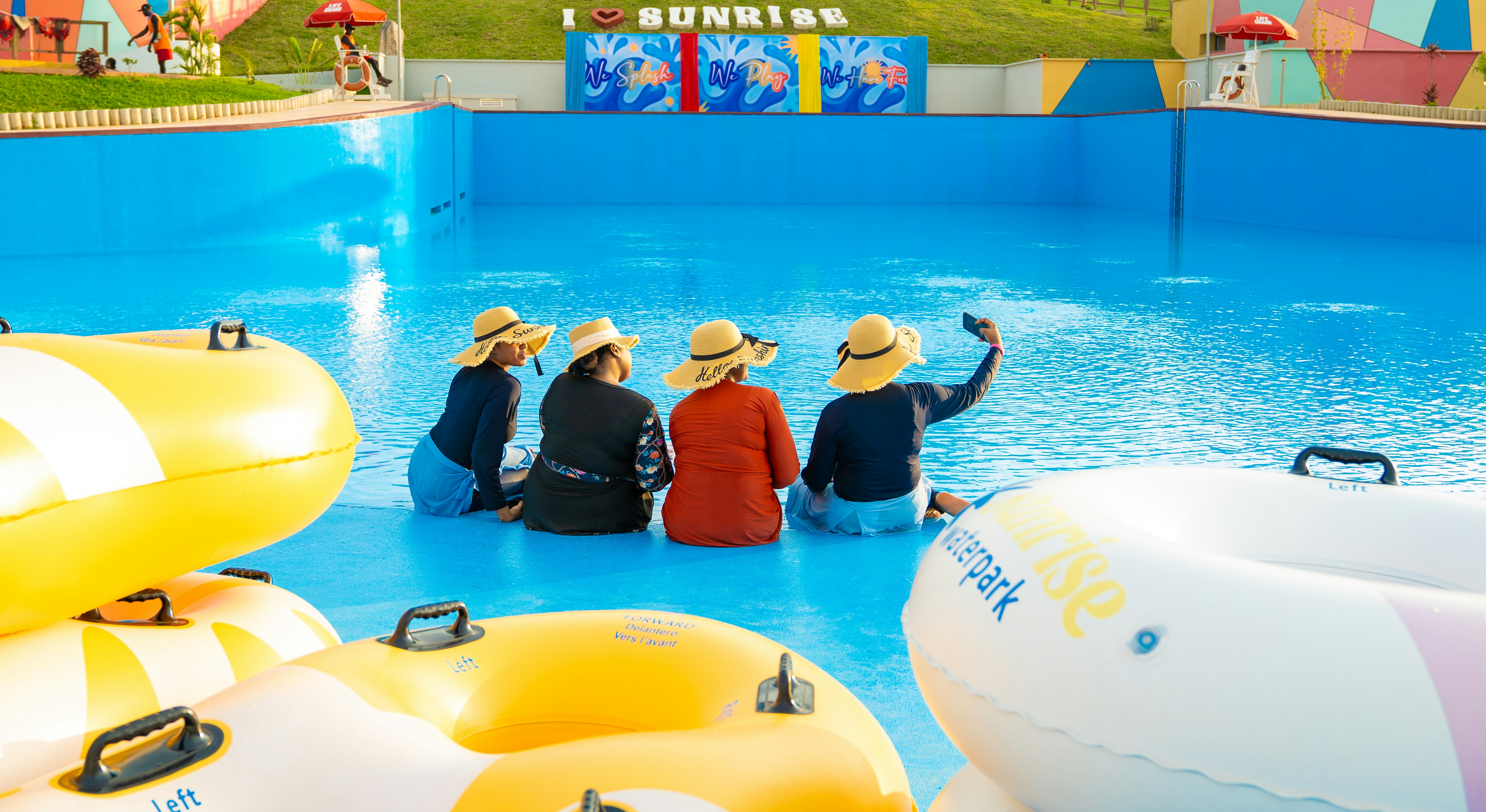 Poolside Crew: Hats, Hydro-Pool, and a Wide-Blue Backdrop