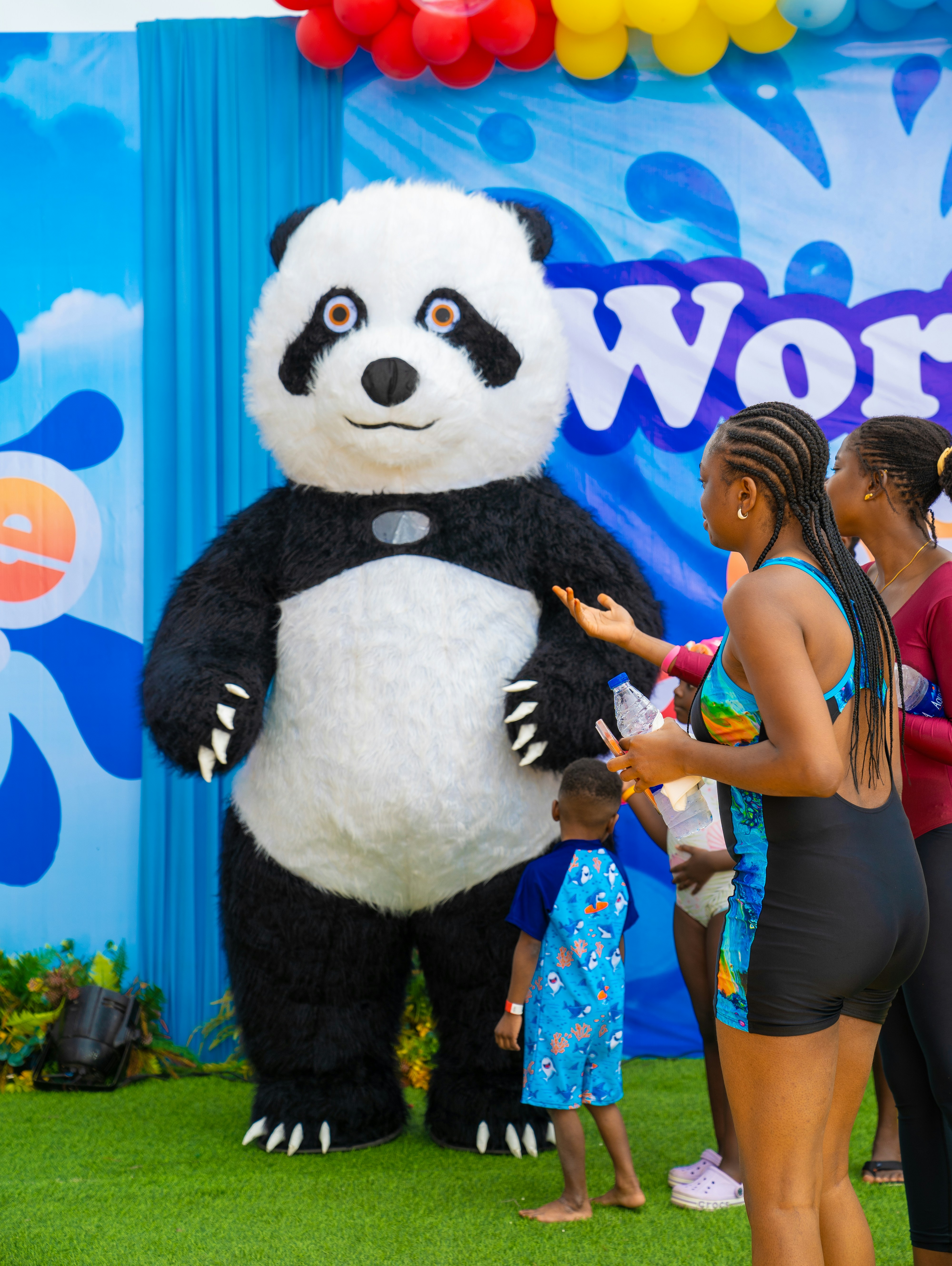 Panda Meet-and-Greet: A Family Moment by the Bright Carnival Backdrop
