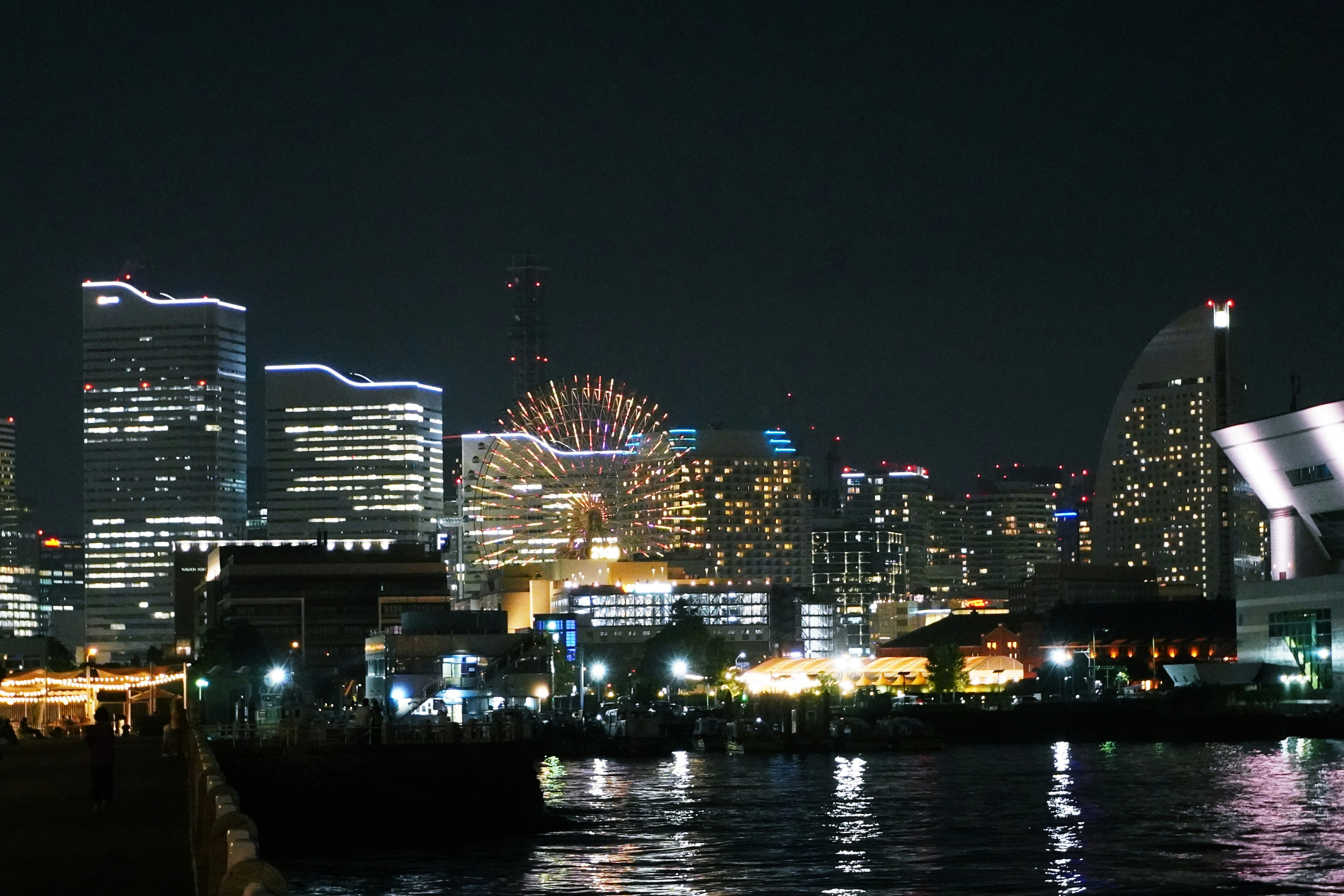 Neon Harbor: City Lights Reflecting on Calm Waters