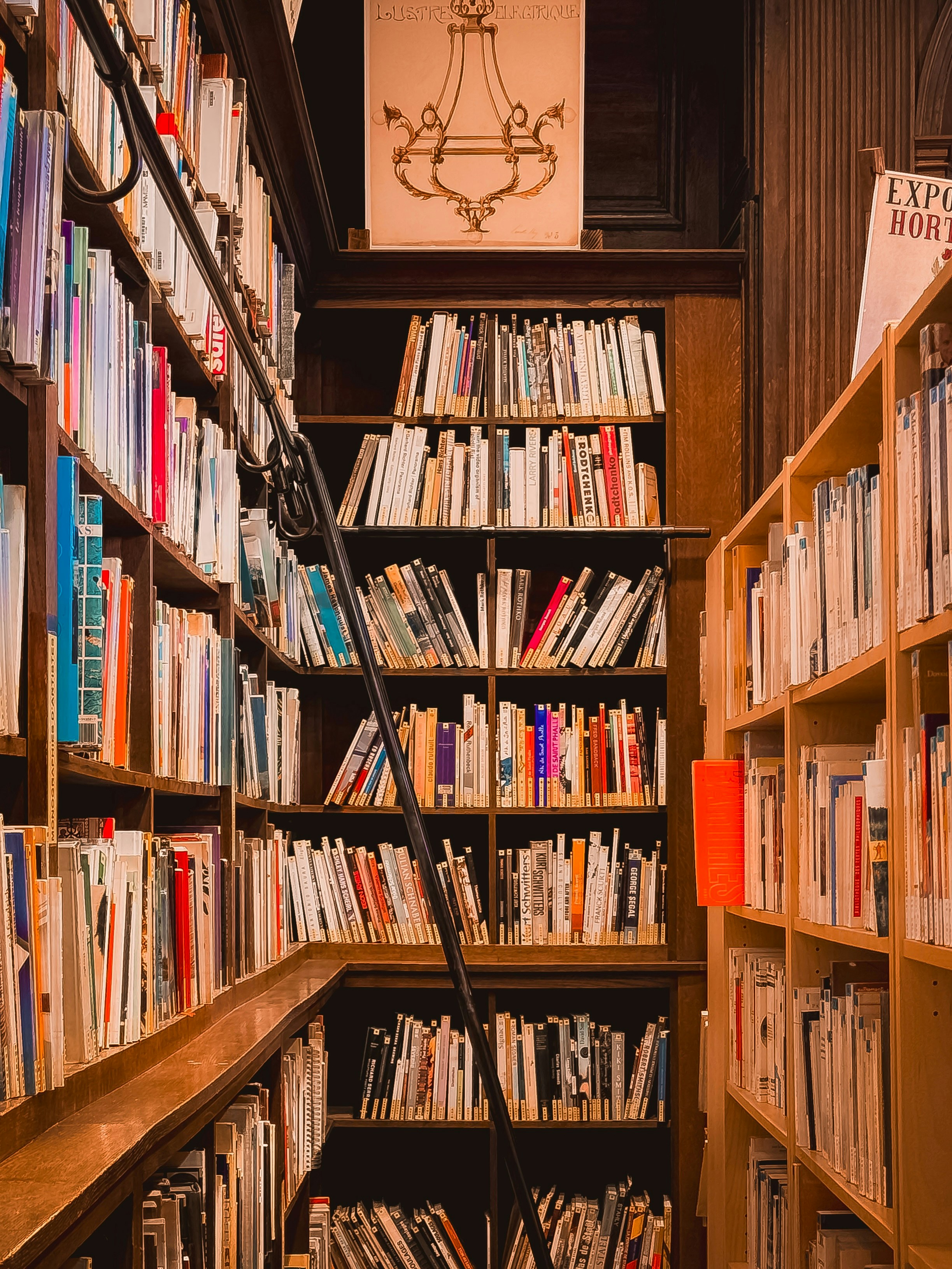 A Narrow Aisle of Quiet Stacks: Books Leaning Against Time