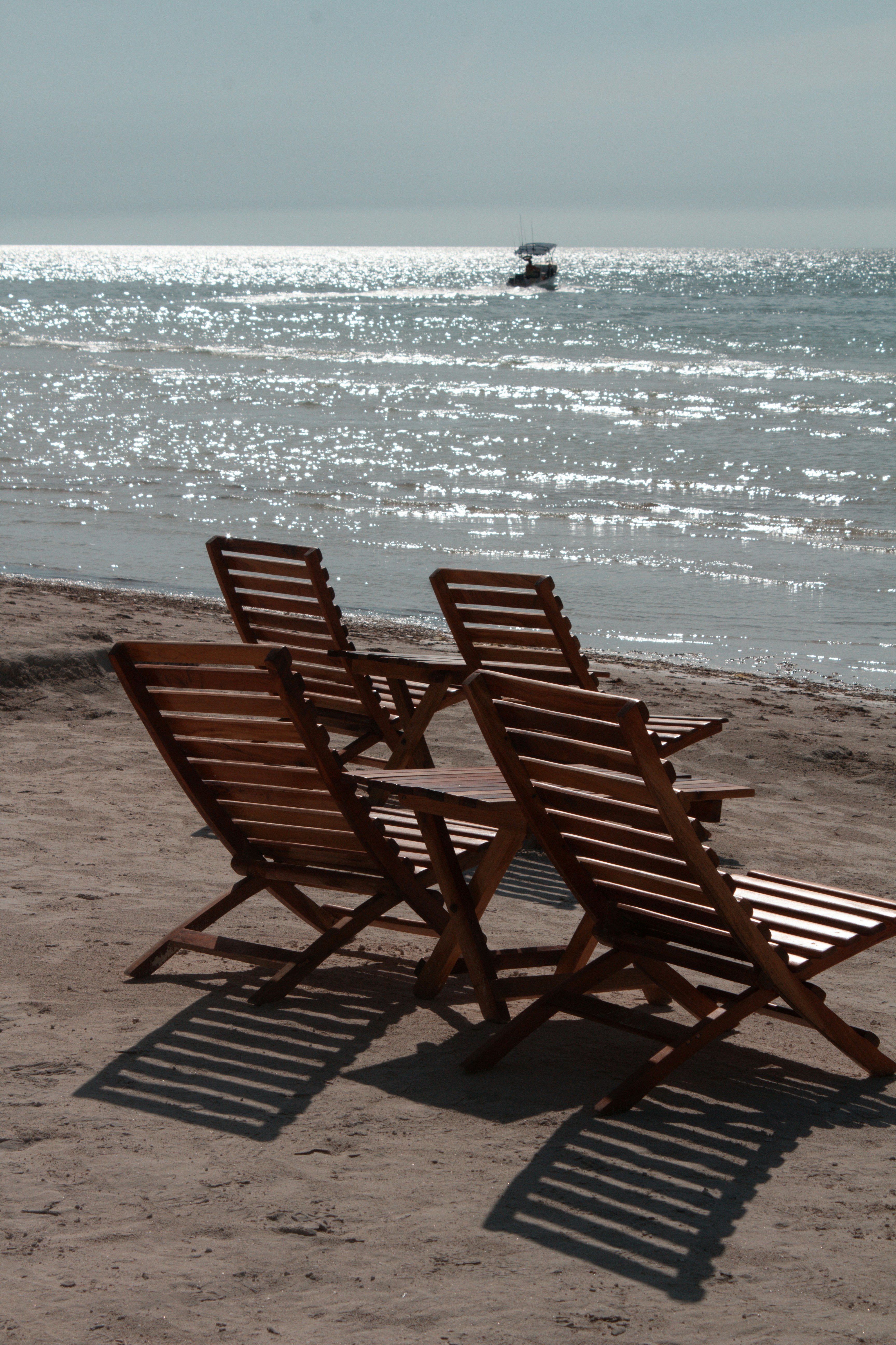 Sunlit Chairs on the Quiet Shore