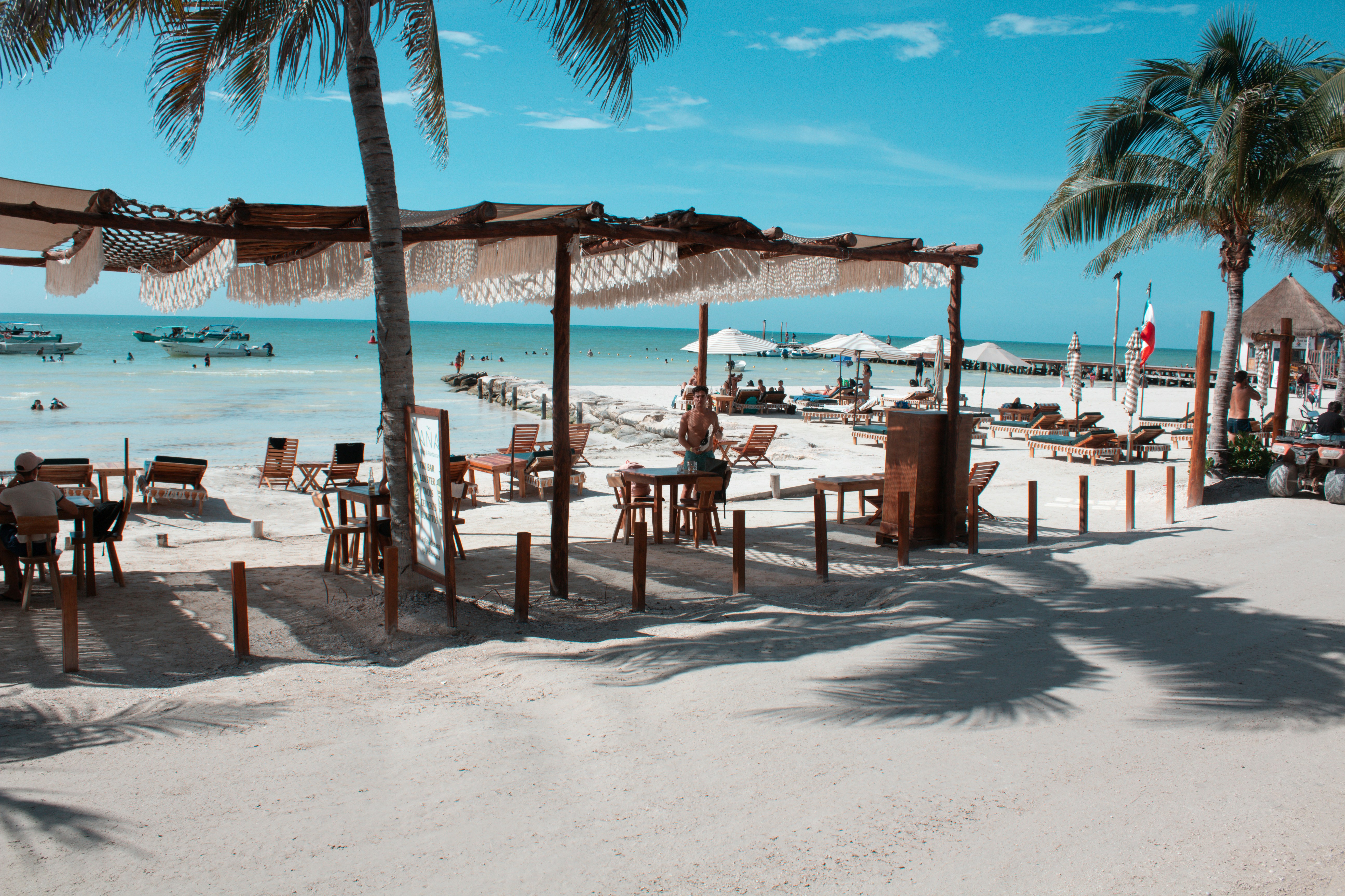 Sunlit Beach Café Rows Along Turquoise Calm