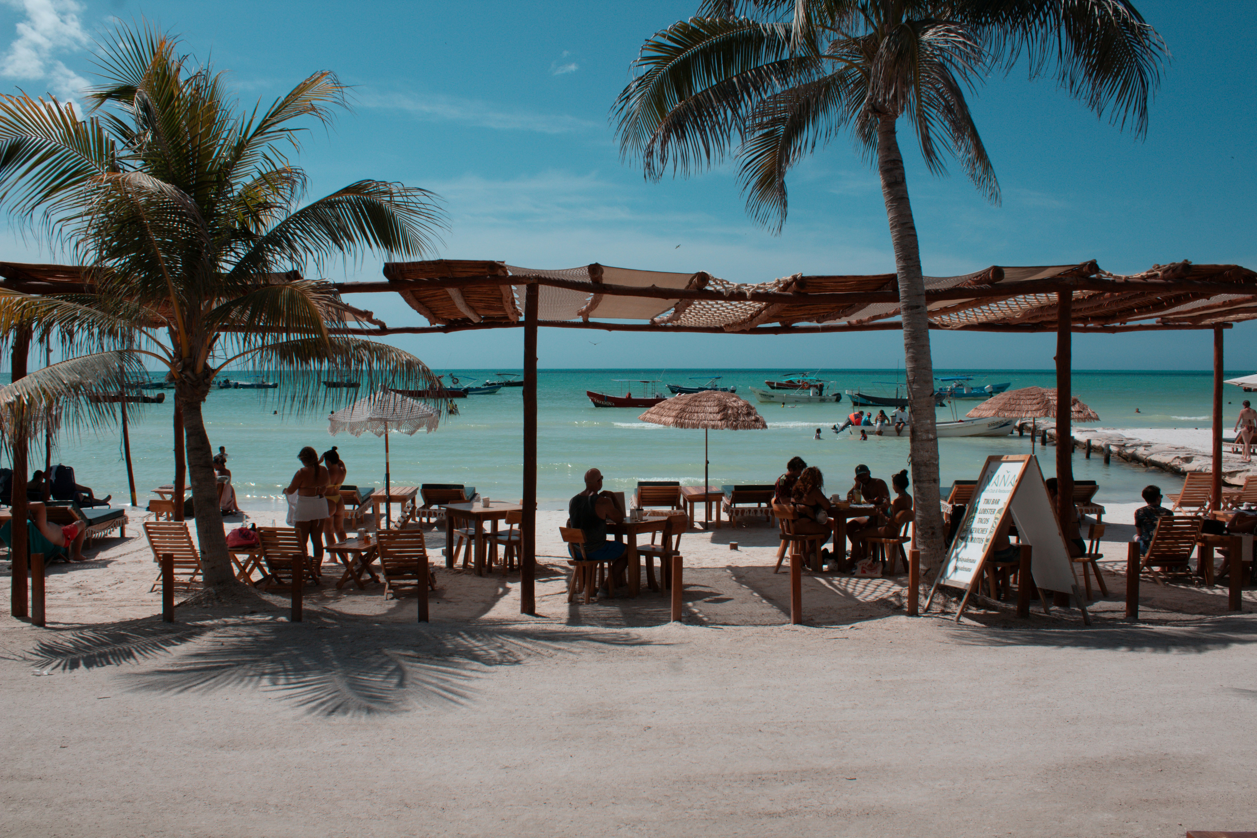 Beachside Café Terrace Framed by Palms and Turquoise Sea