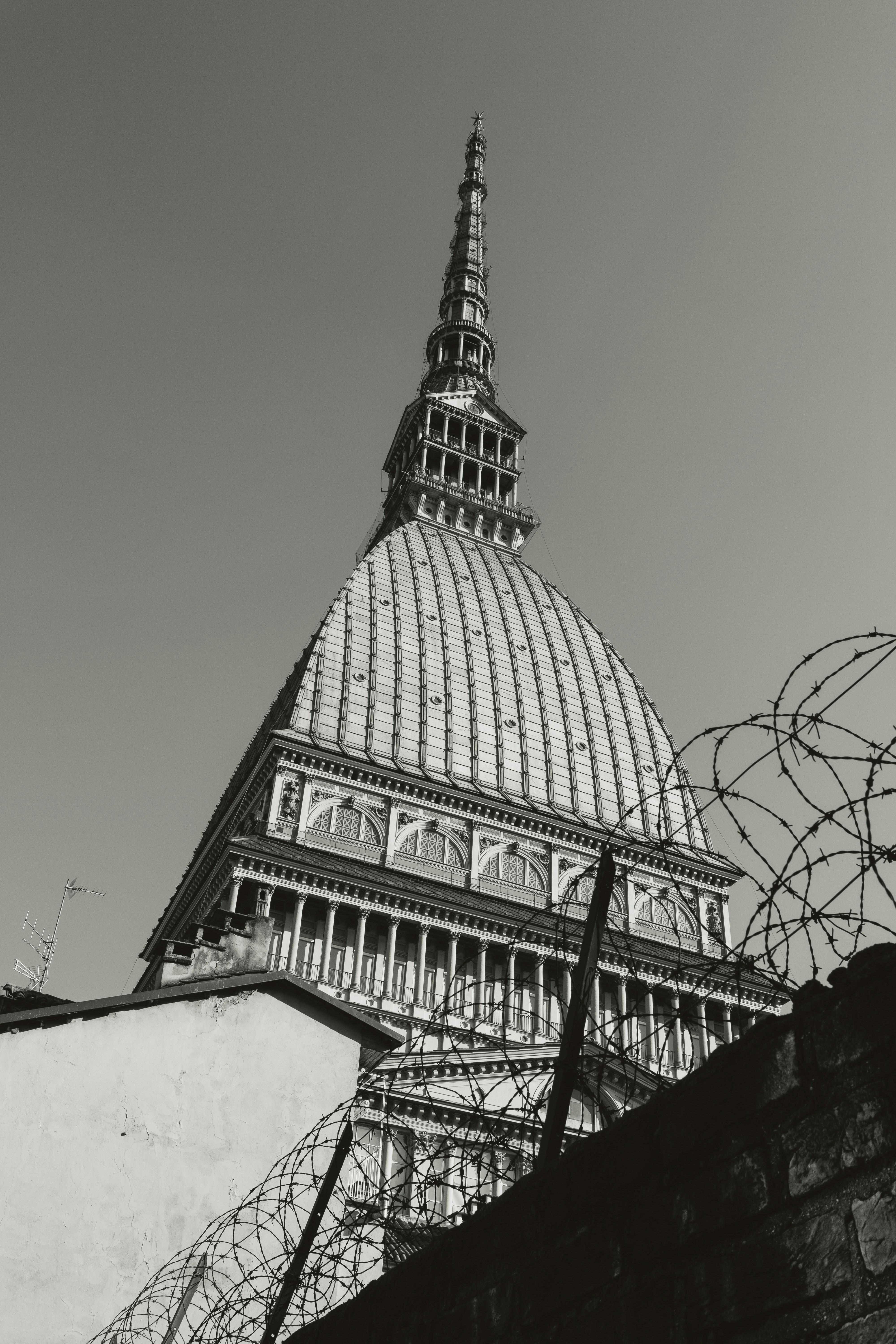 Spire Over Barbed Walls: A Juxtaposition of Architecture and Barbed Echoes