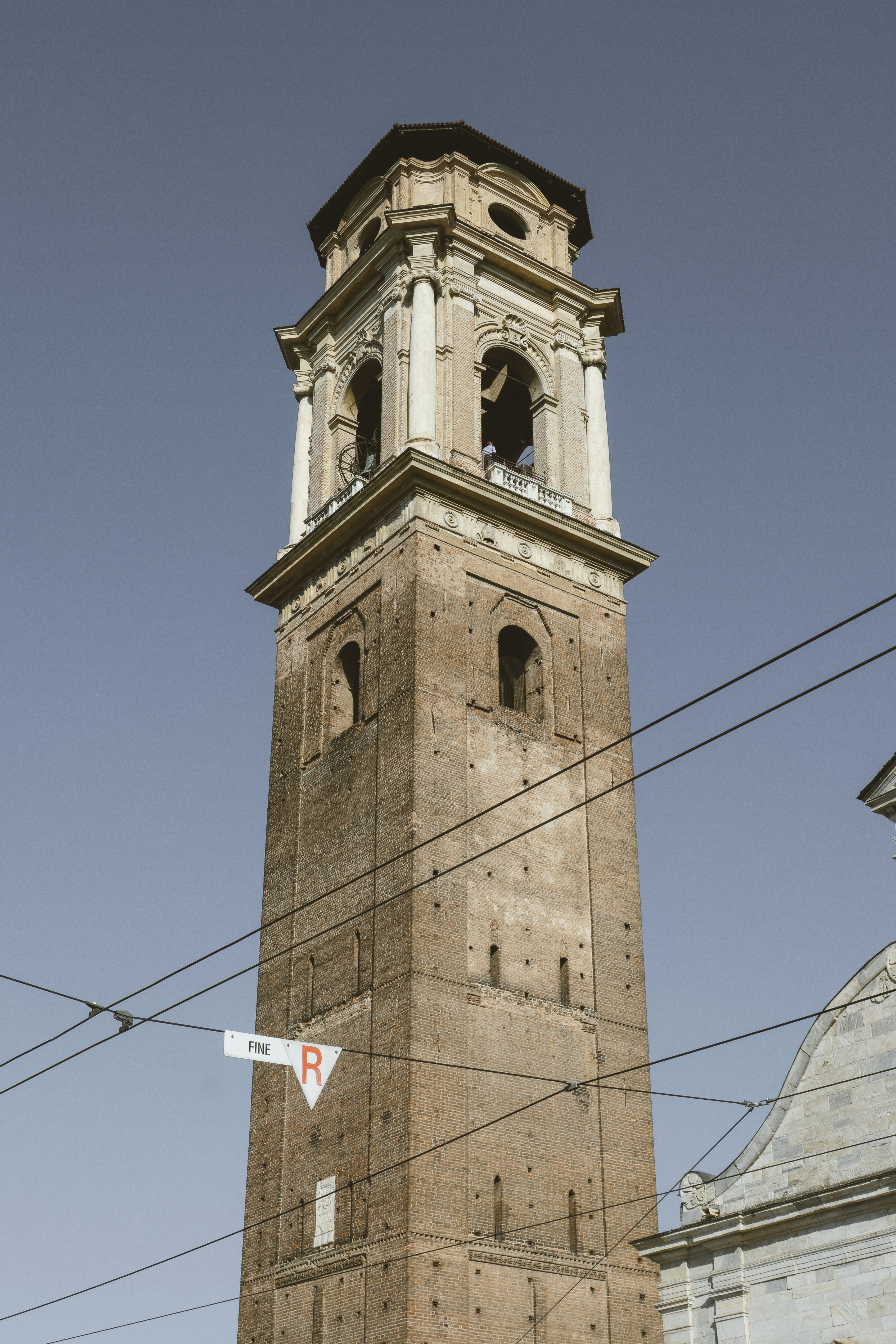 Clocktower Rising: A Brick Bell-Tower Against a Clear Sky