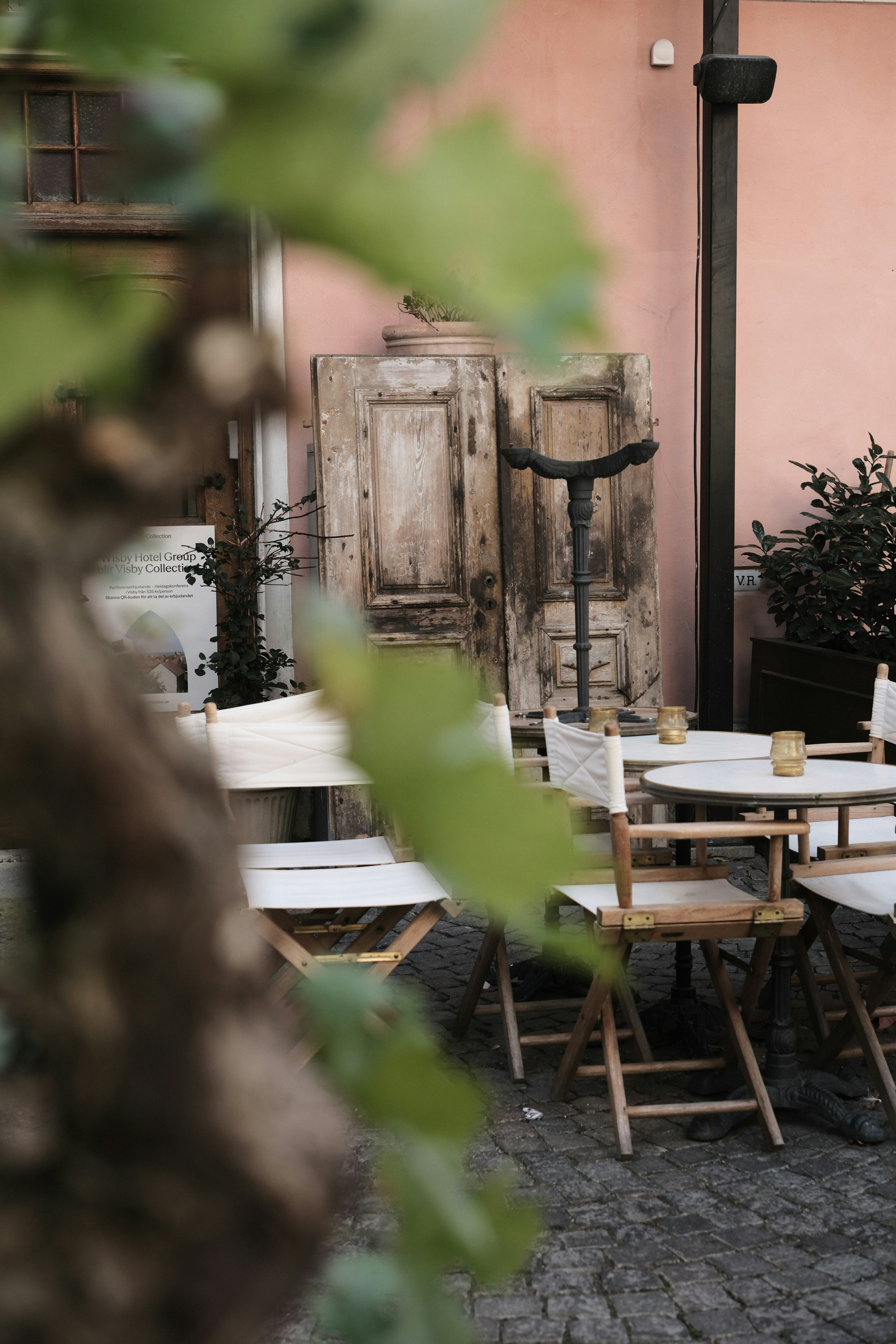 Rustic doorway tableau behind cafe courtyard