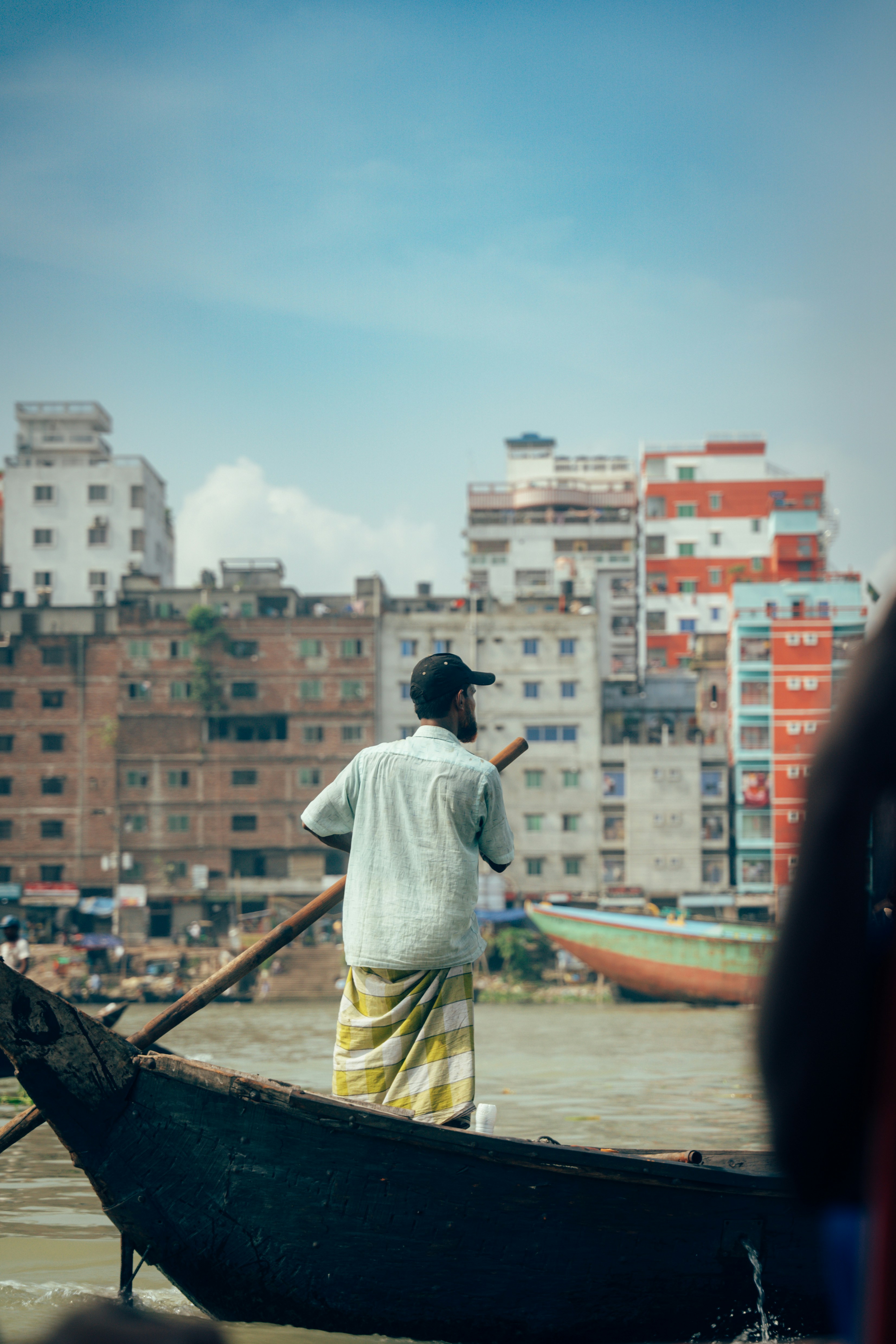 A Fisherman at Dusk: Quiet Focus Amidst Colorful Riverscape