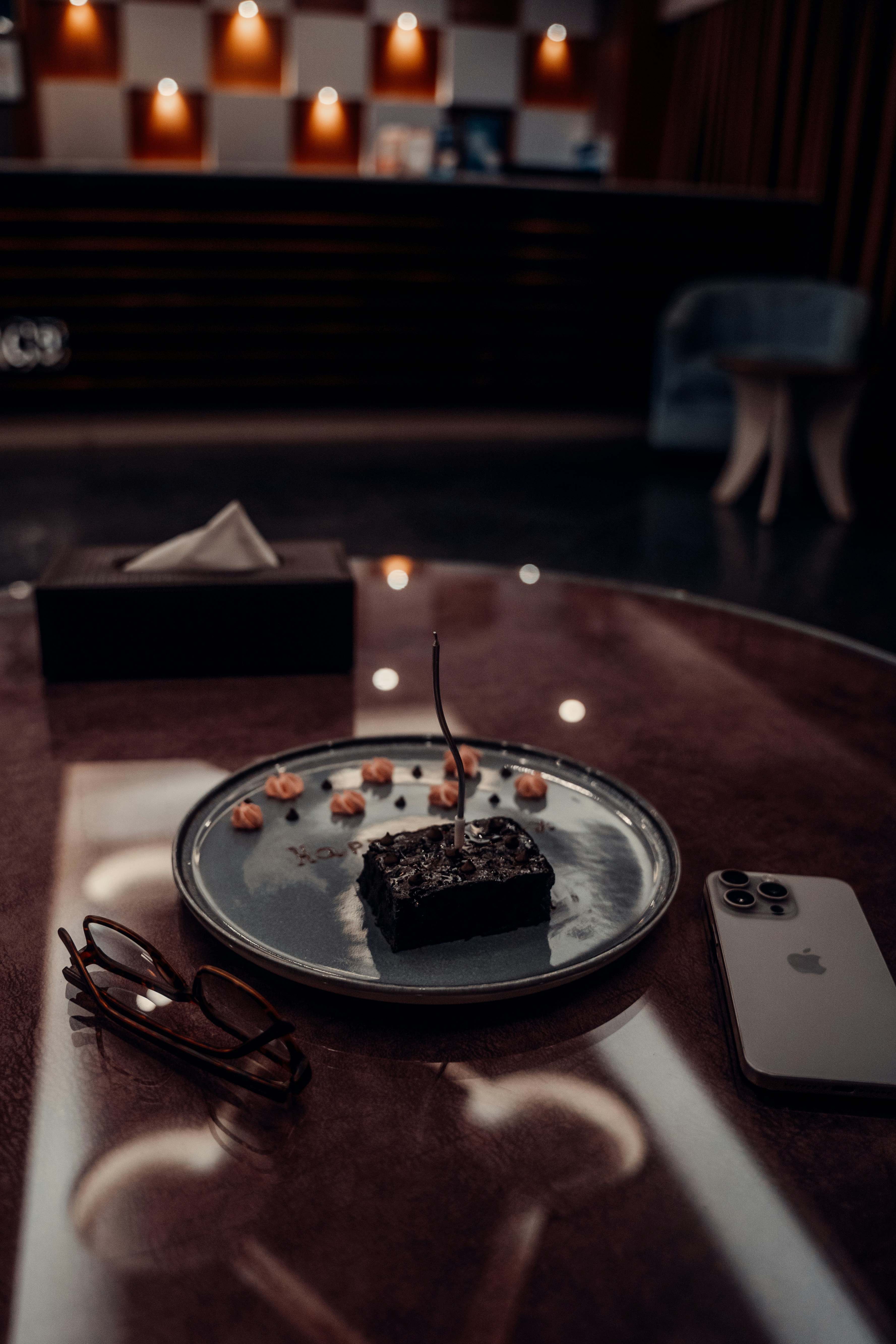 Midnight Slice: A Candlelit Dessert Resting by a Modern Lounge