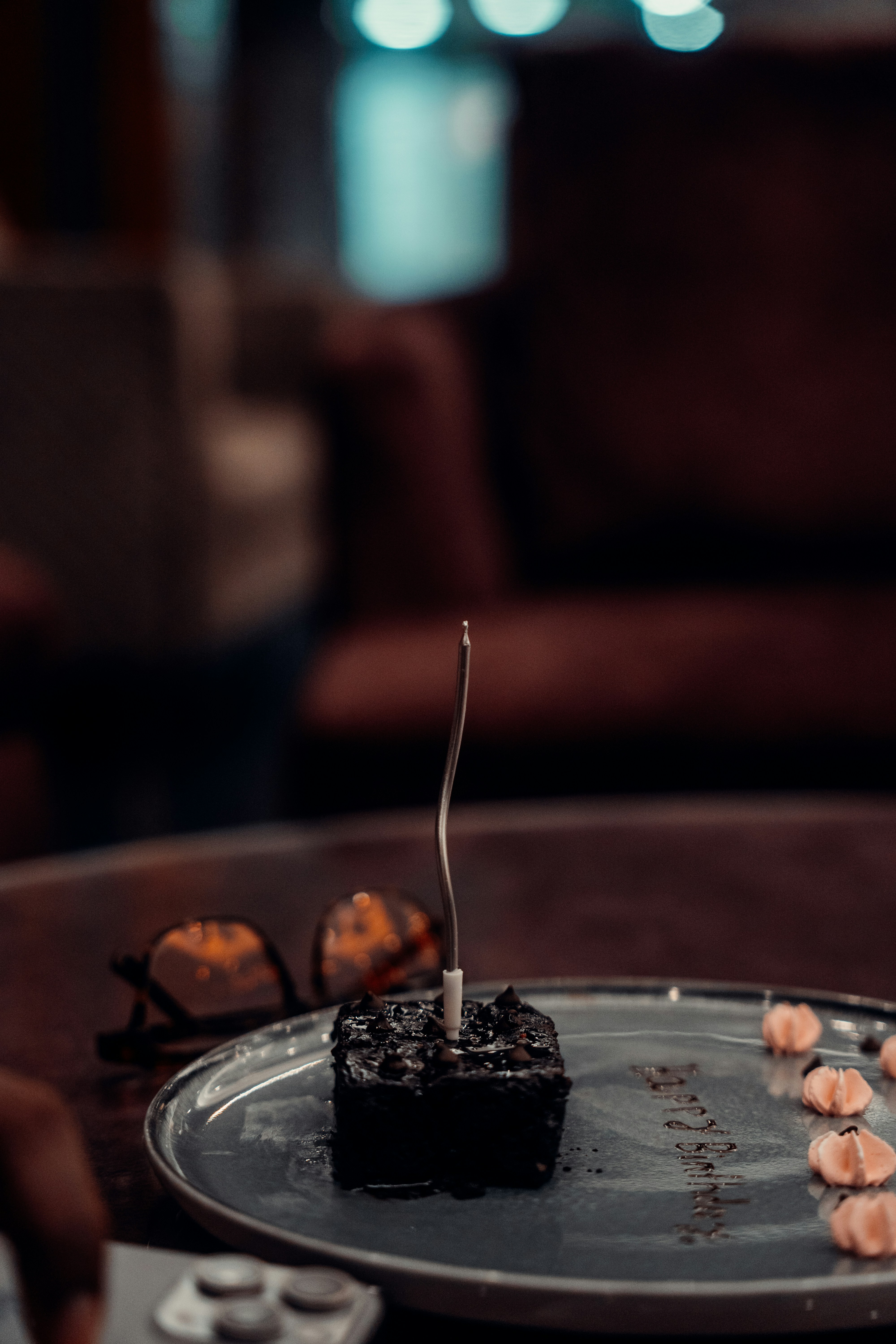 Single Candle Crowned by a Charred Cube on a Silky Plate