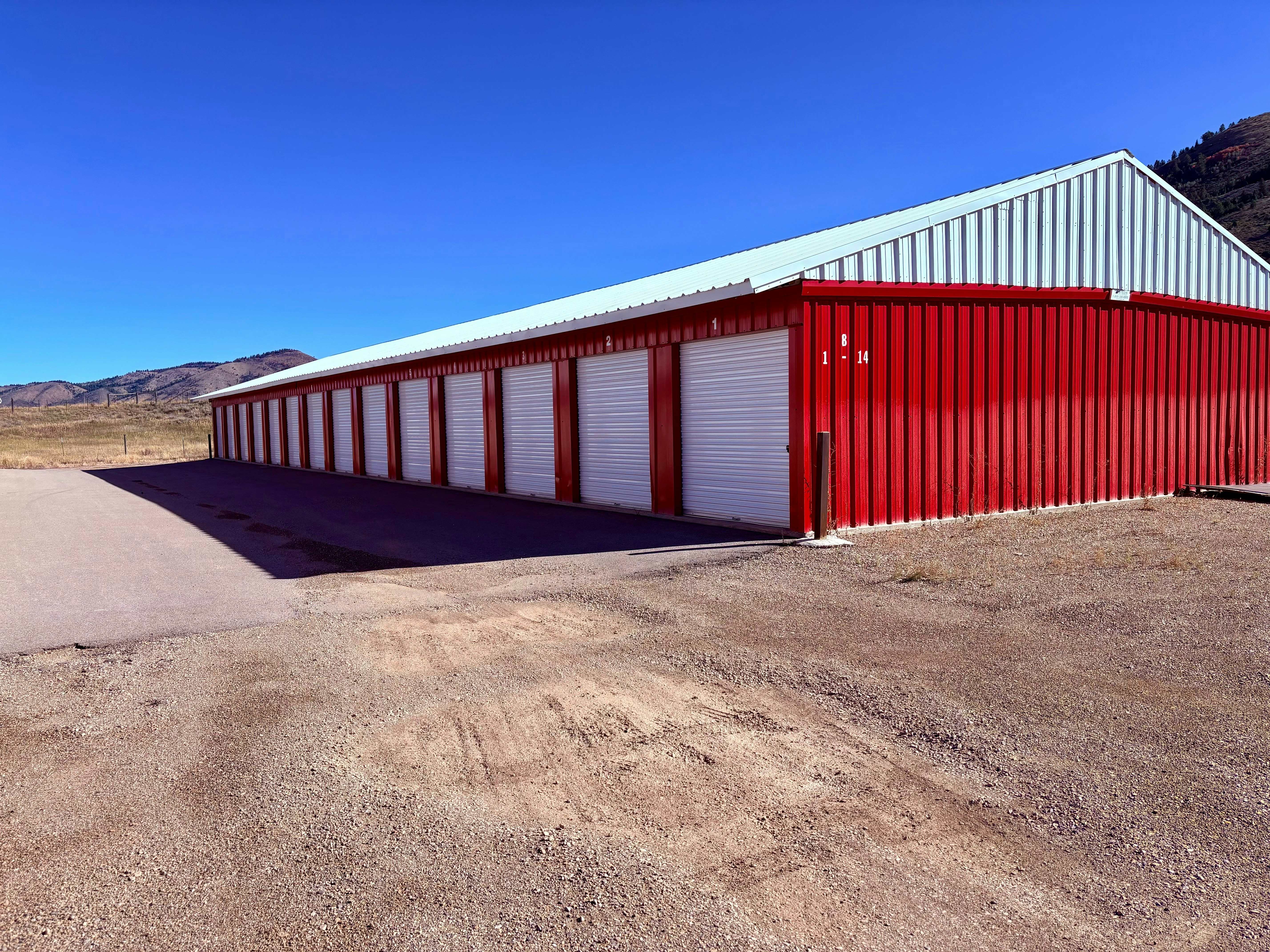 Red Row of Storage Units Under a Wide Blue Sky