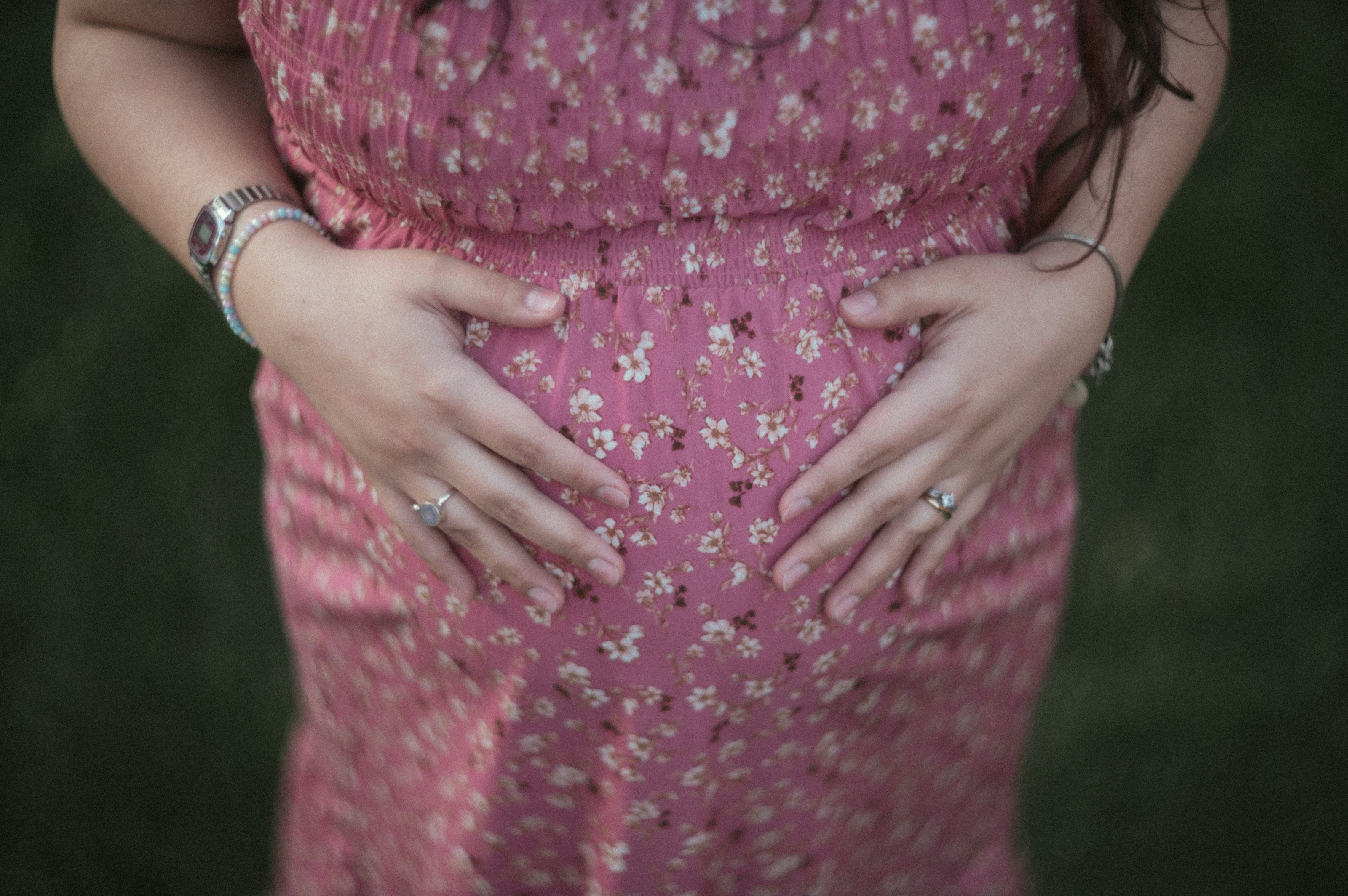 Pregnant Moment: Gentle Hands Framing a Floral Embrace