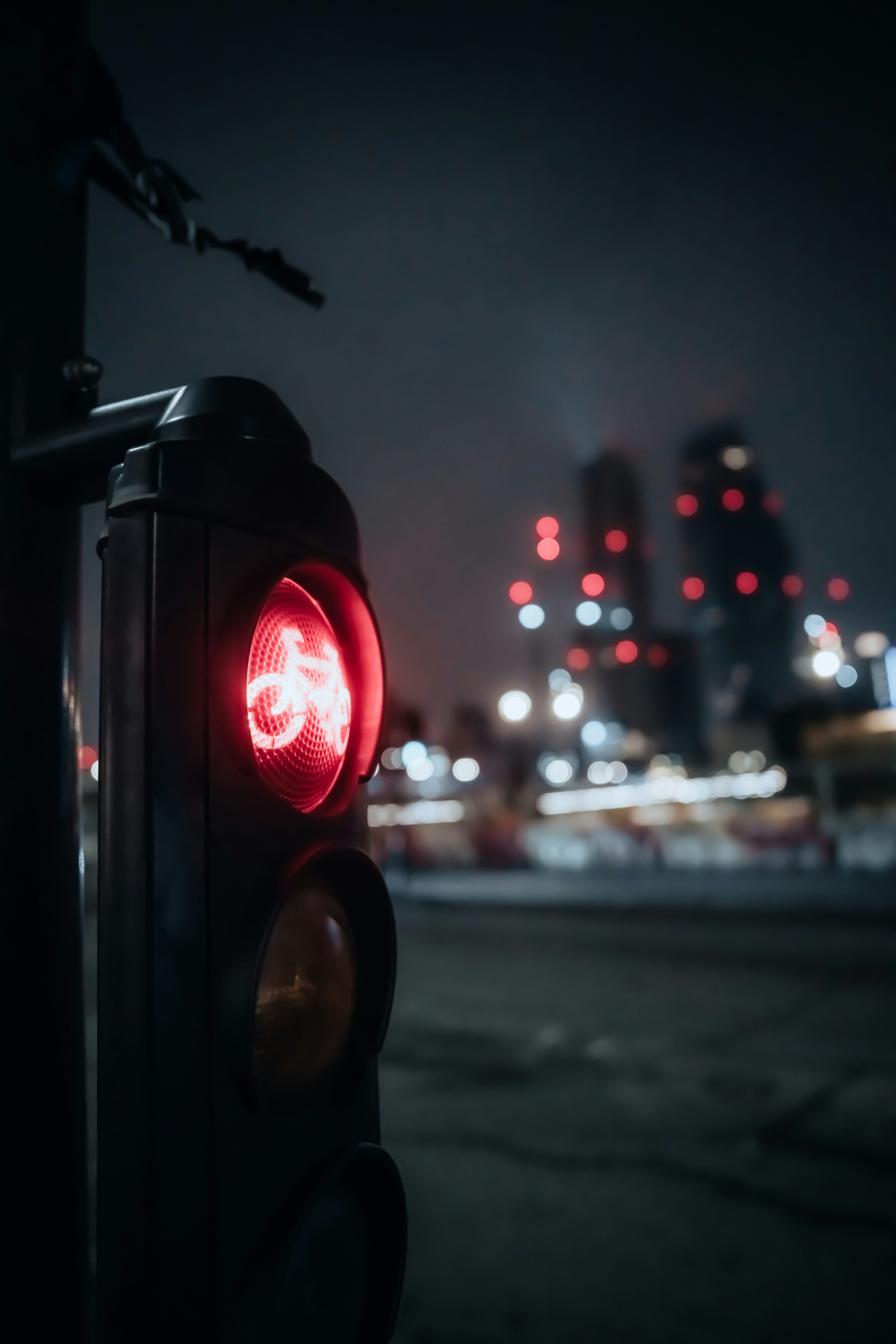 Red Signal, Nightscape: A Bicycle Light Glows in the Urban Abyss