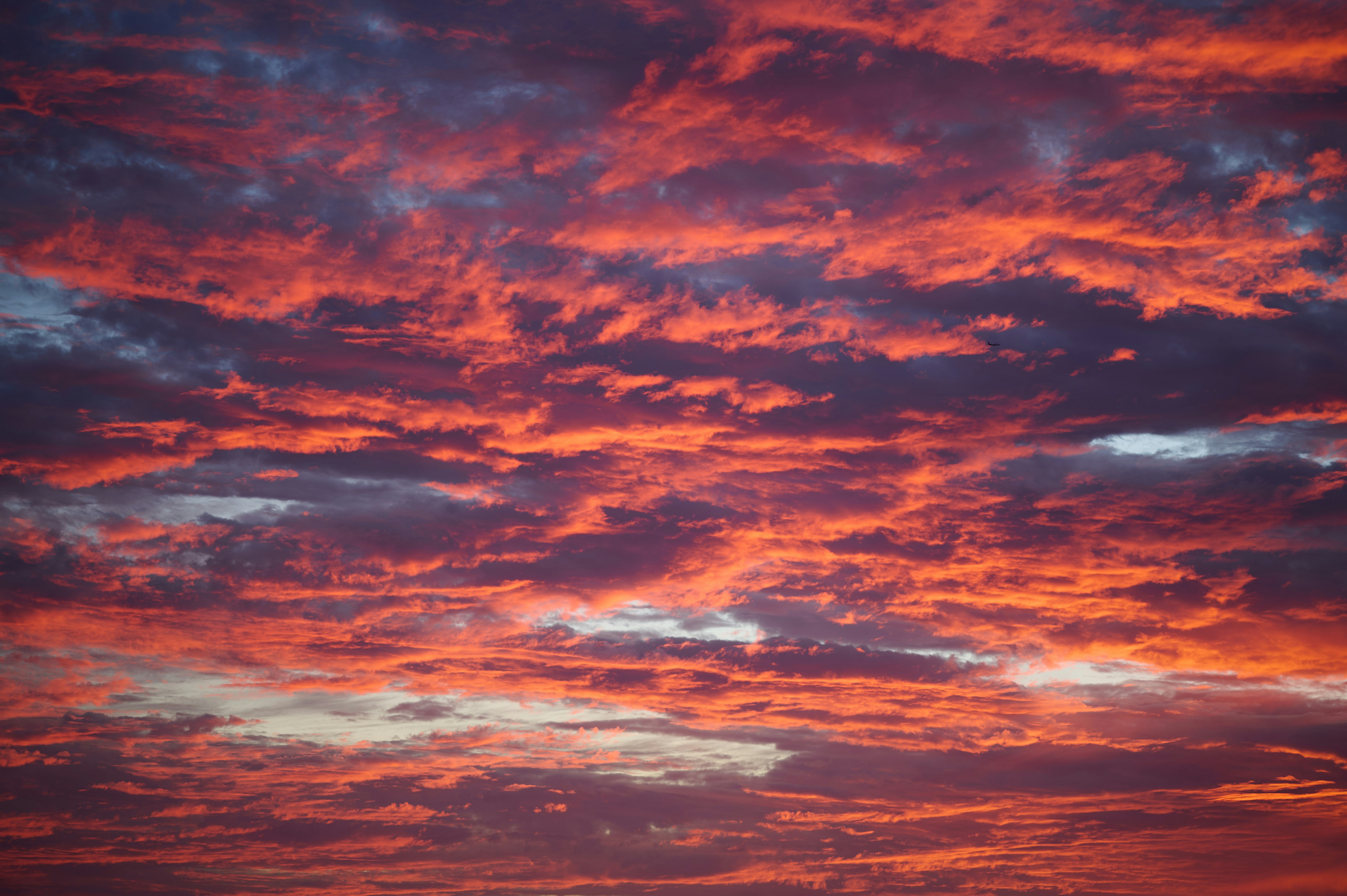 Embers in the Sky: A Fiery Dusk Over Gentle Clouds