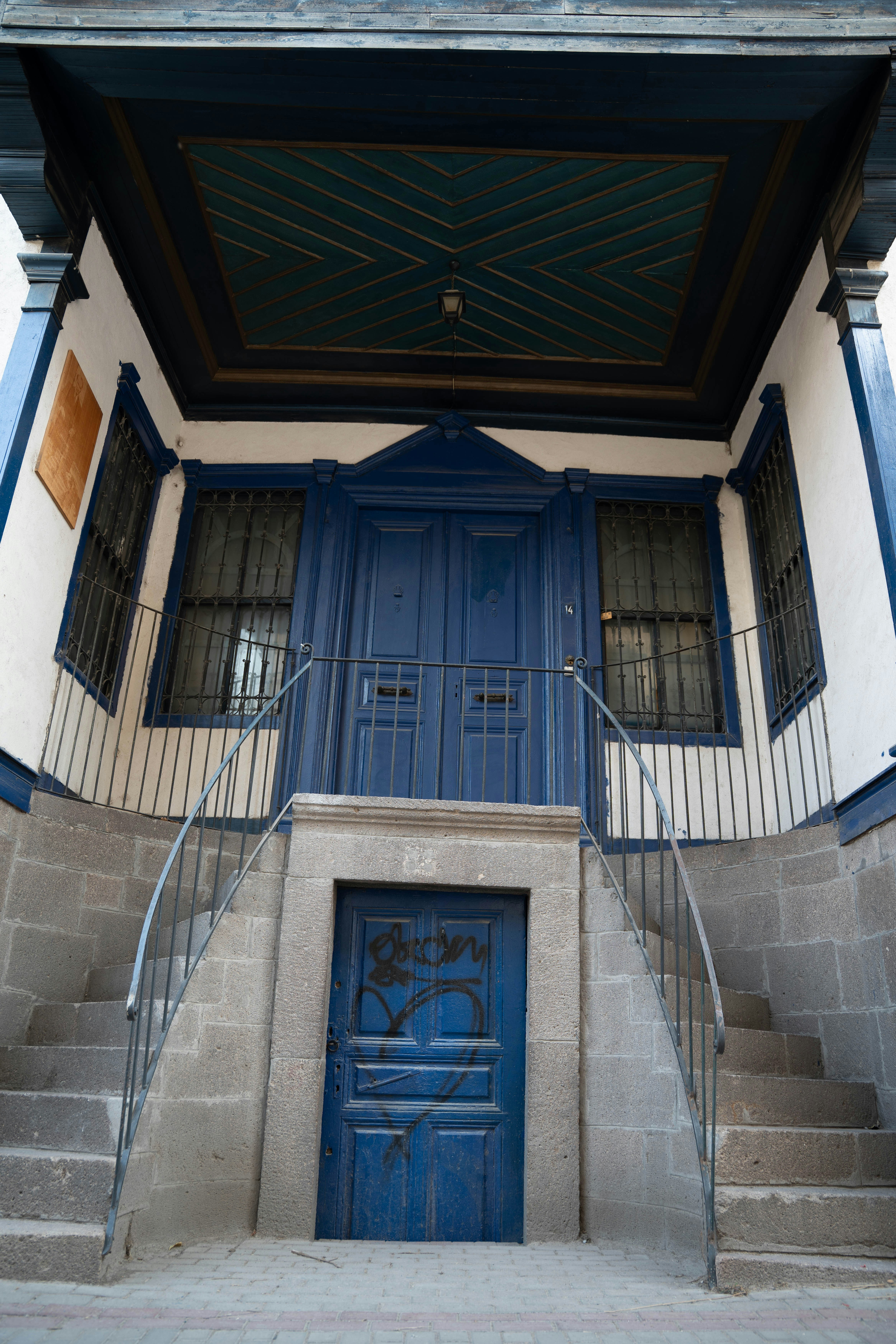 Cerulean Doorway: A Staircase to the Blue Facade of a Historic Building